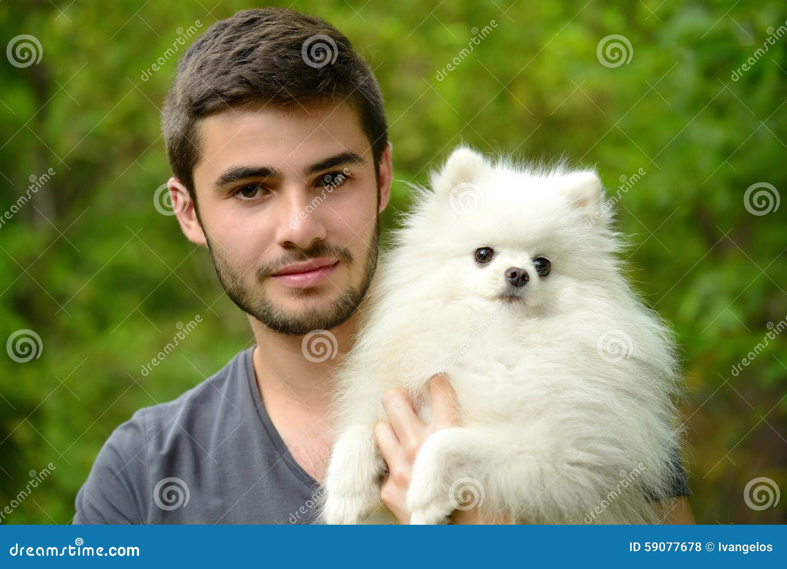 Young Man Holding German Spitz Puppy Stock Photo - Image of furry ...