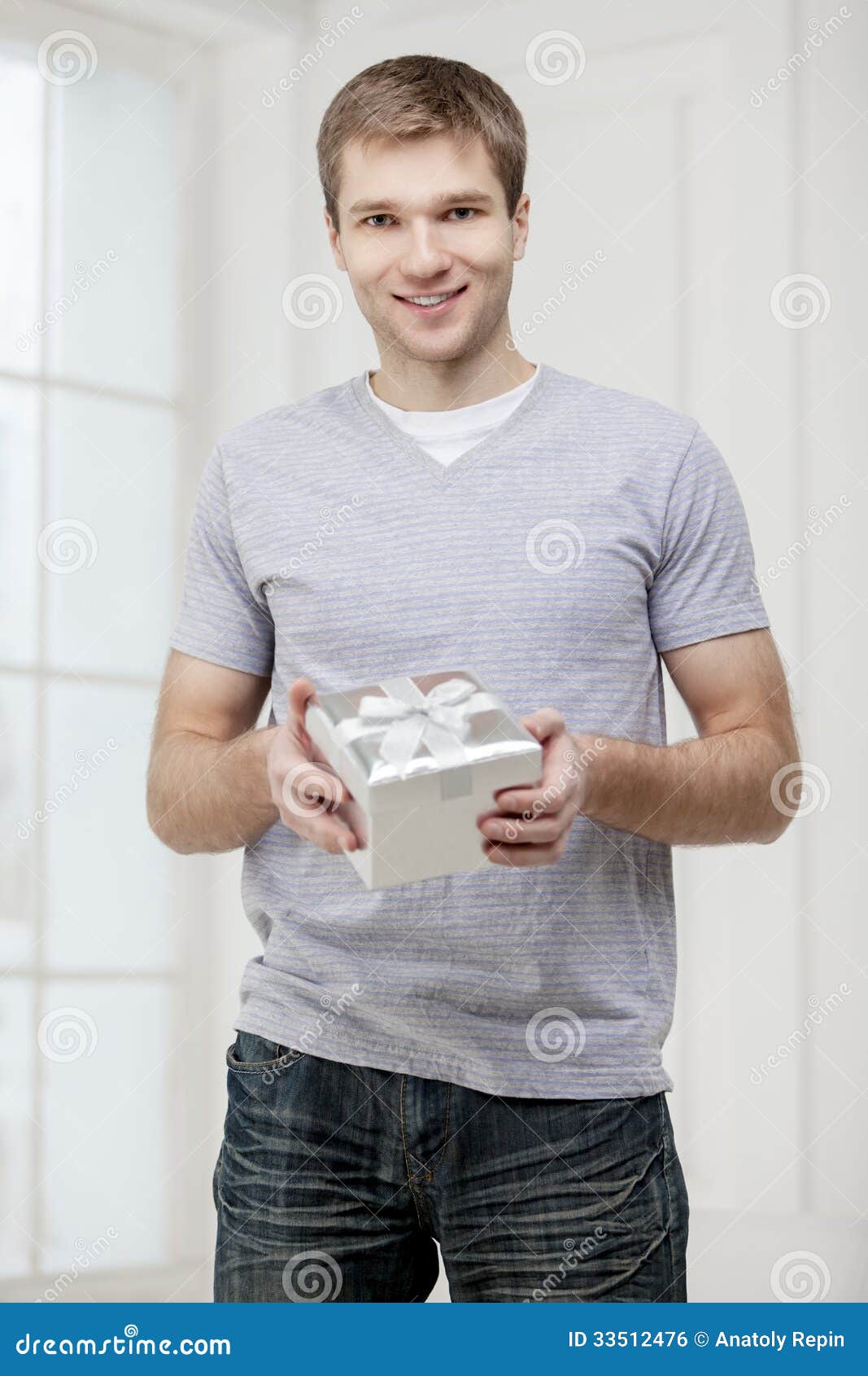 Young man holding gift box stock photo. Image of lounge - 33512476