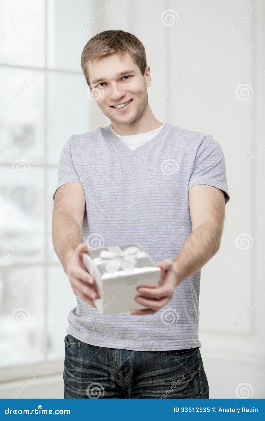 Young man holding gift box stock image. Image of holding - 33512535