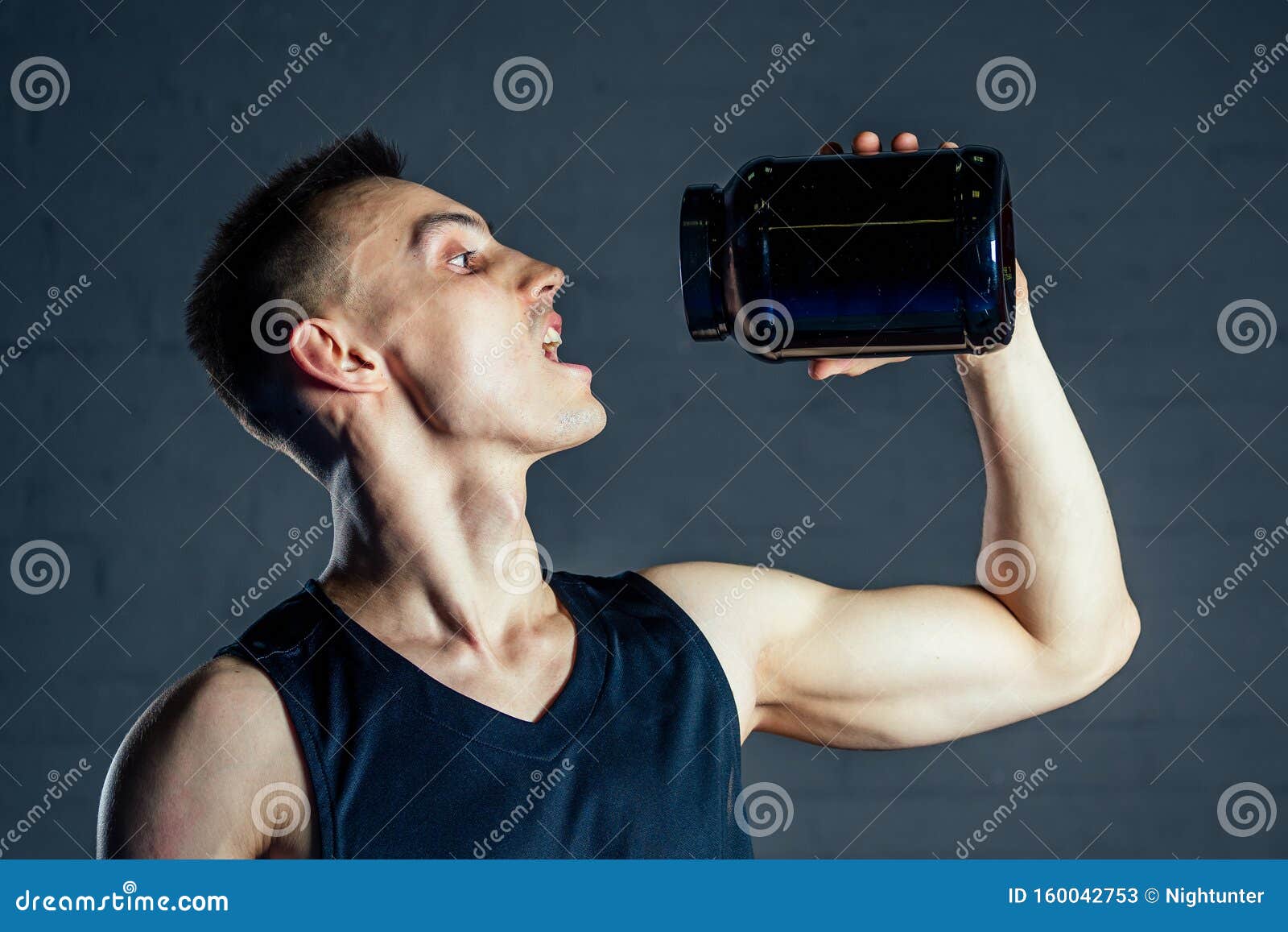 A Young Man Holding a Jar of Protein in the Gym Stock Image - Image of ...