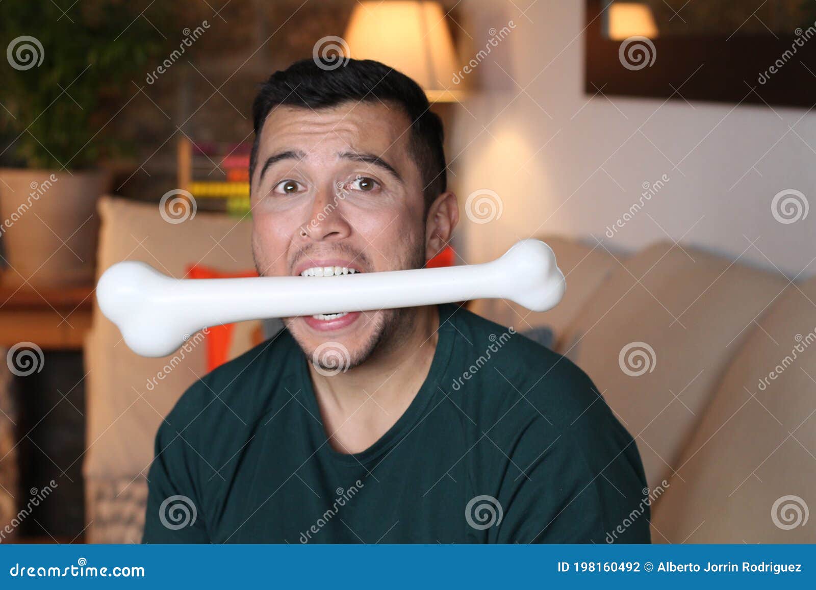 Young Man Holding Largo Bone in Mouth Stock Photo - Image of mouth ...