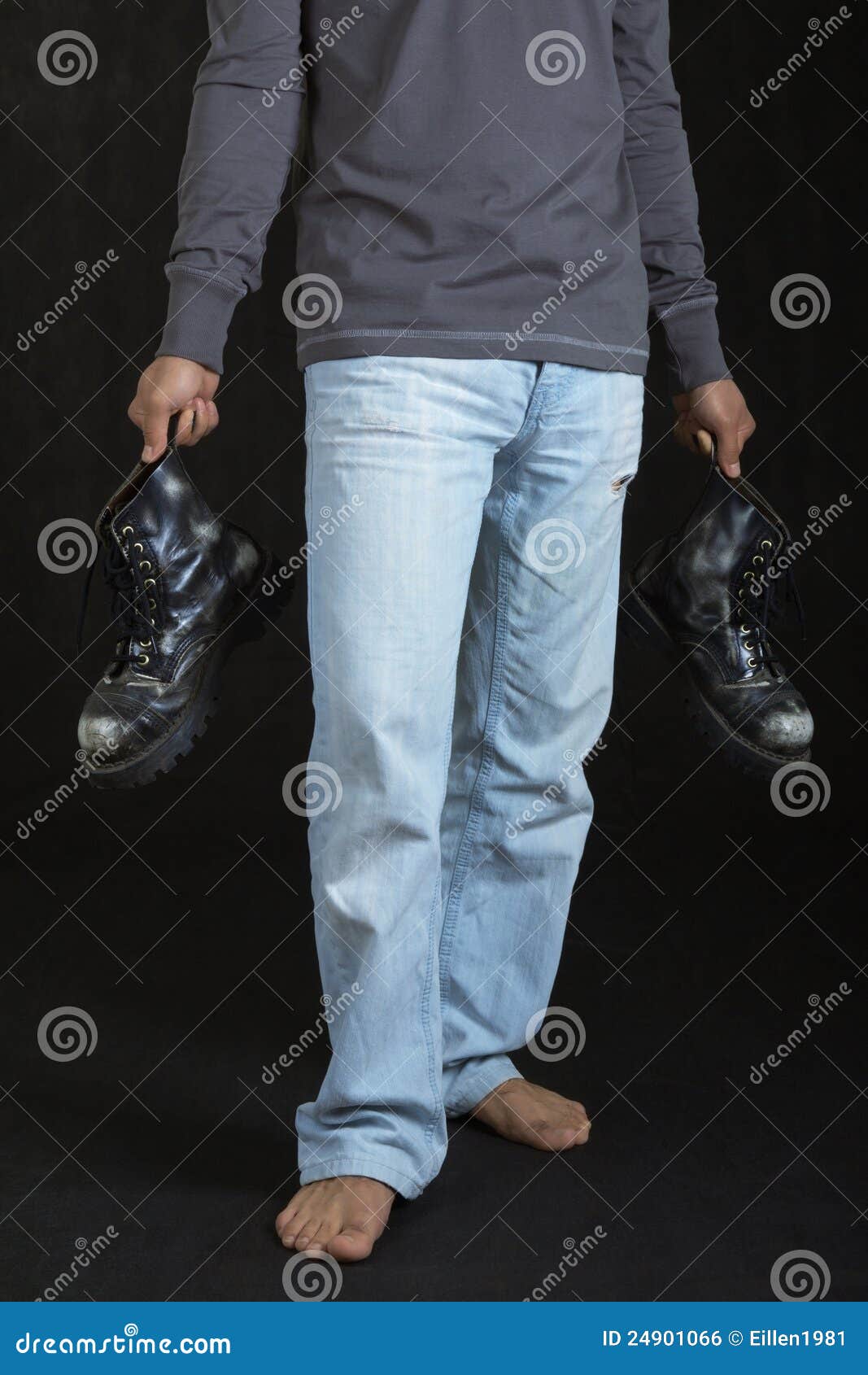 Young Man Holding a Pair of Shoes on Black Stock Photo - Image of human ...