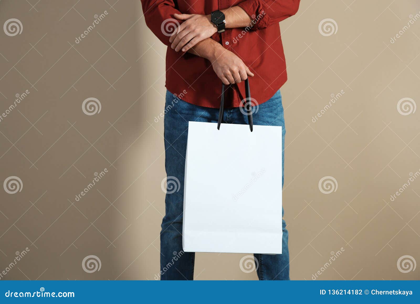 Young Man Holding Paper Bag on Color Background, Closeup Stock Photo ... Young Man Holding Paper Bag on Color Background, Closeup Stock Photo ...