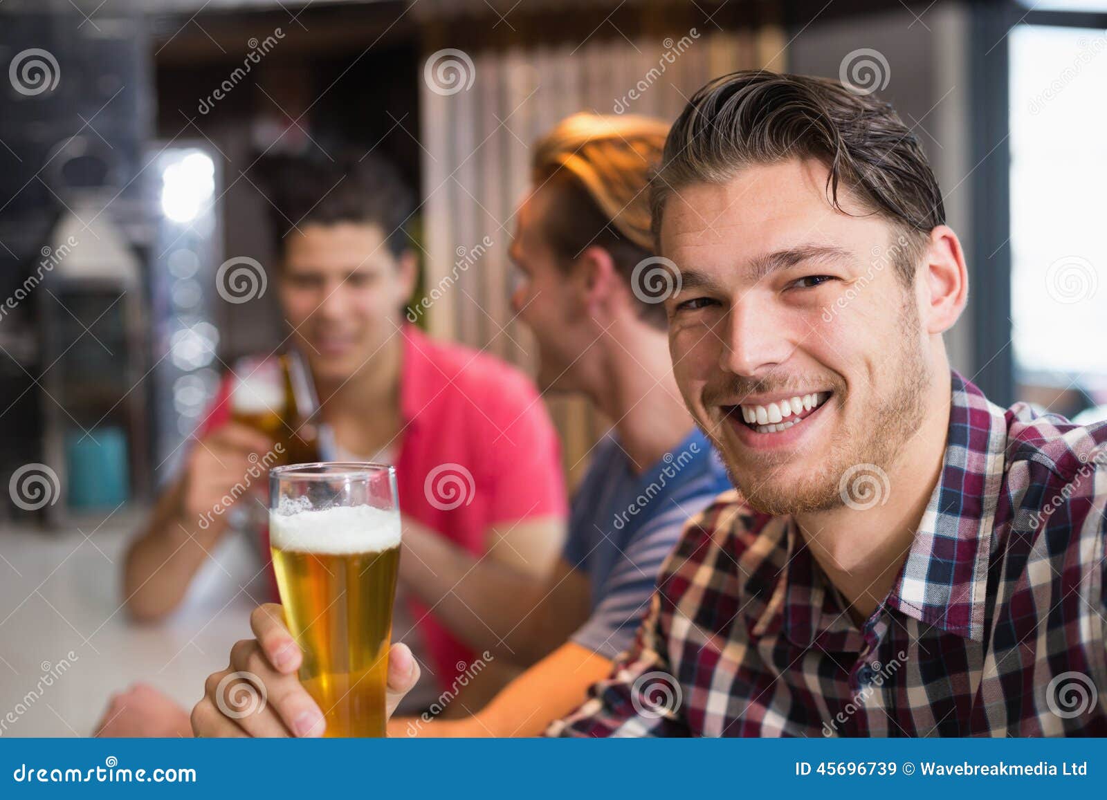 Young Man Holding Pint of Beer Stock Image - Image of looking ...