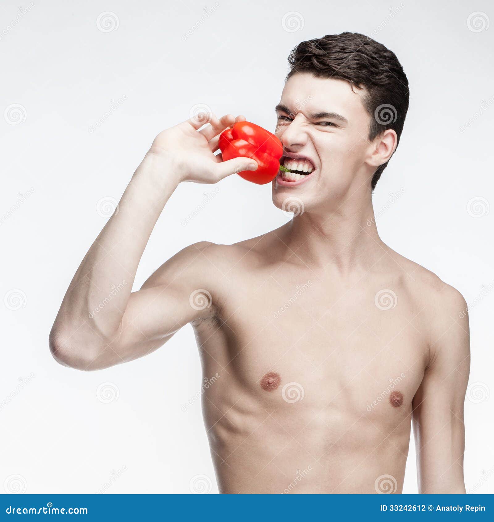 Young Man Holding Red Pepper Stock Photo - Image of looking, brunette ...