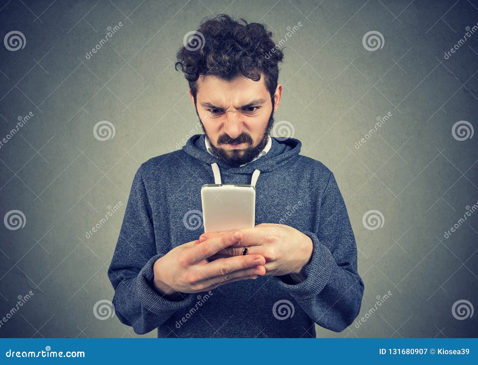 Young Man Holding Smartphone Being Upset with Text Message Stock Image ...