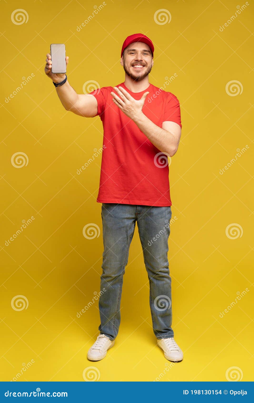 Young Man Holding Smartphone Isolated on Yellow. Stock Photo - Image of ...