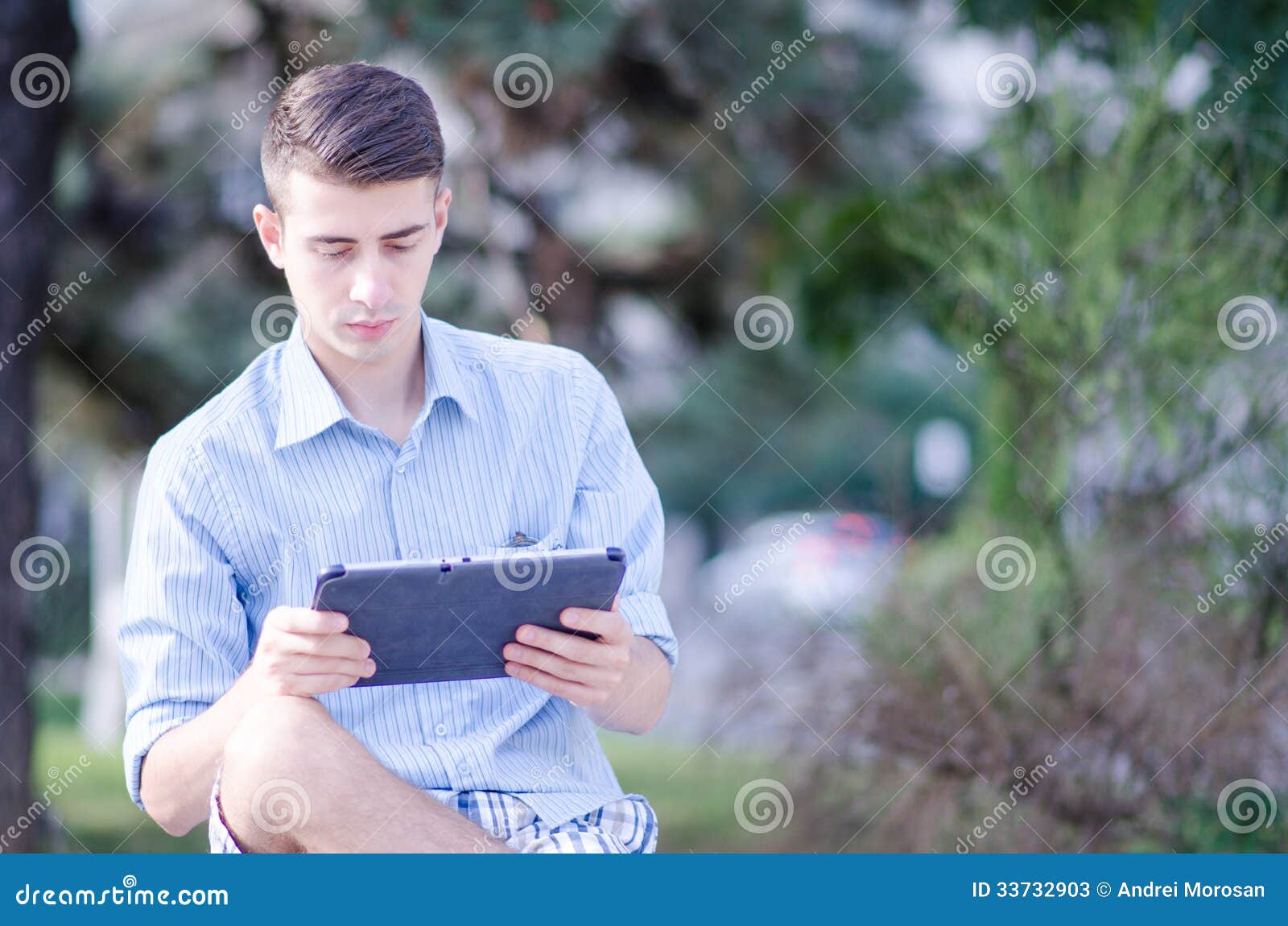 Young man reading tablet stock image. Image of traveling - 33732903