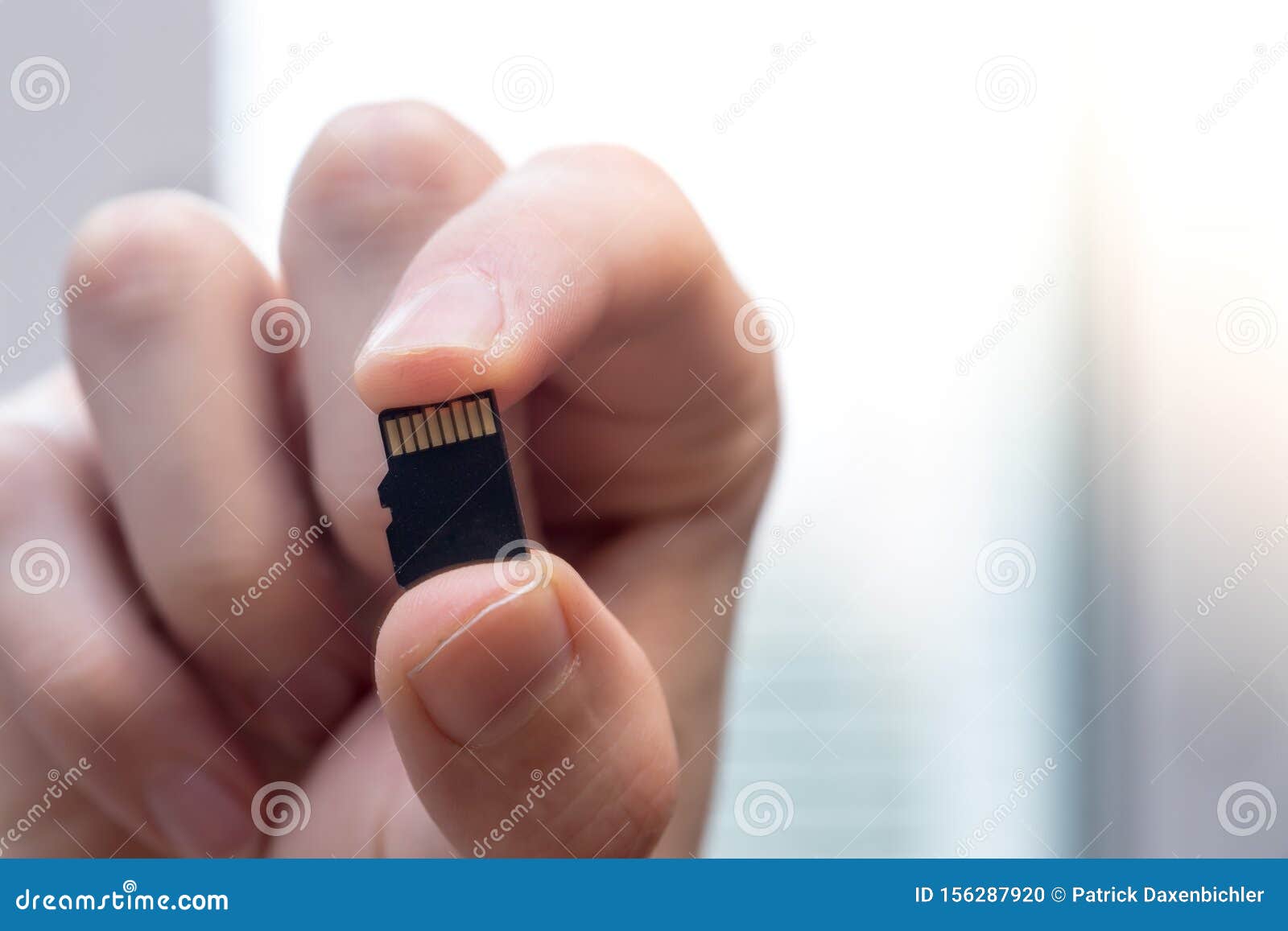 Young Man is Holding a Tiny Memory Card in His Hand, Text Space Stock ...