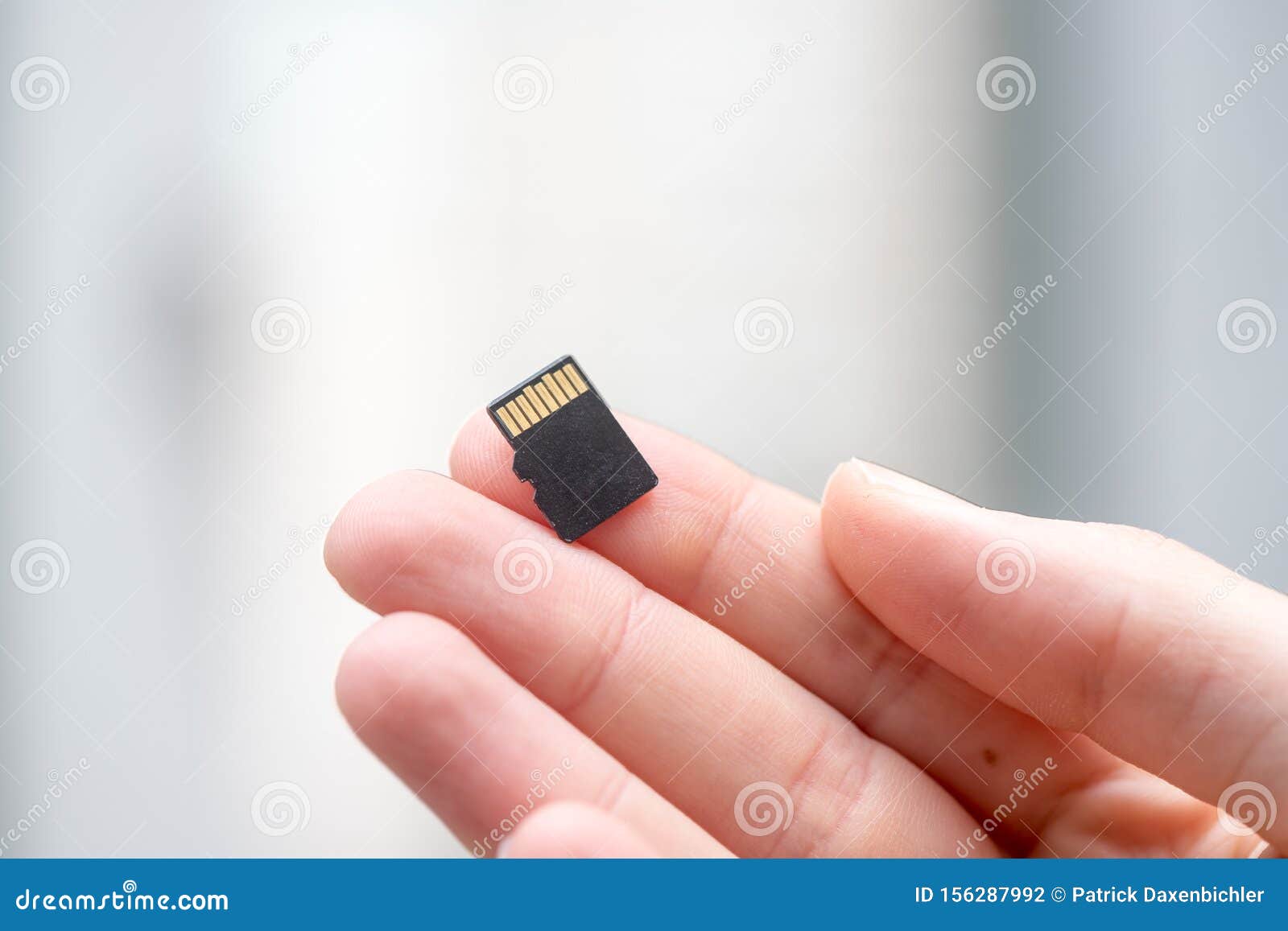 Young Man is Holding a Tiny Memory Card in His Hand, Text Space Stock ...