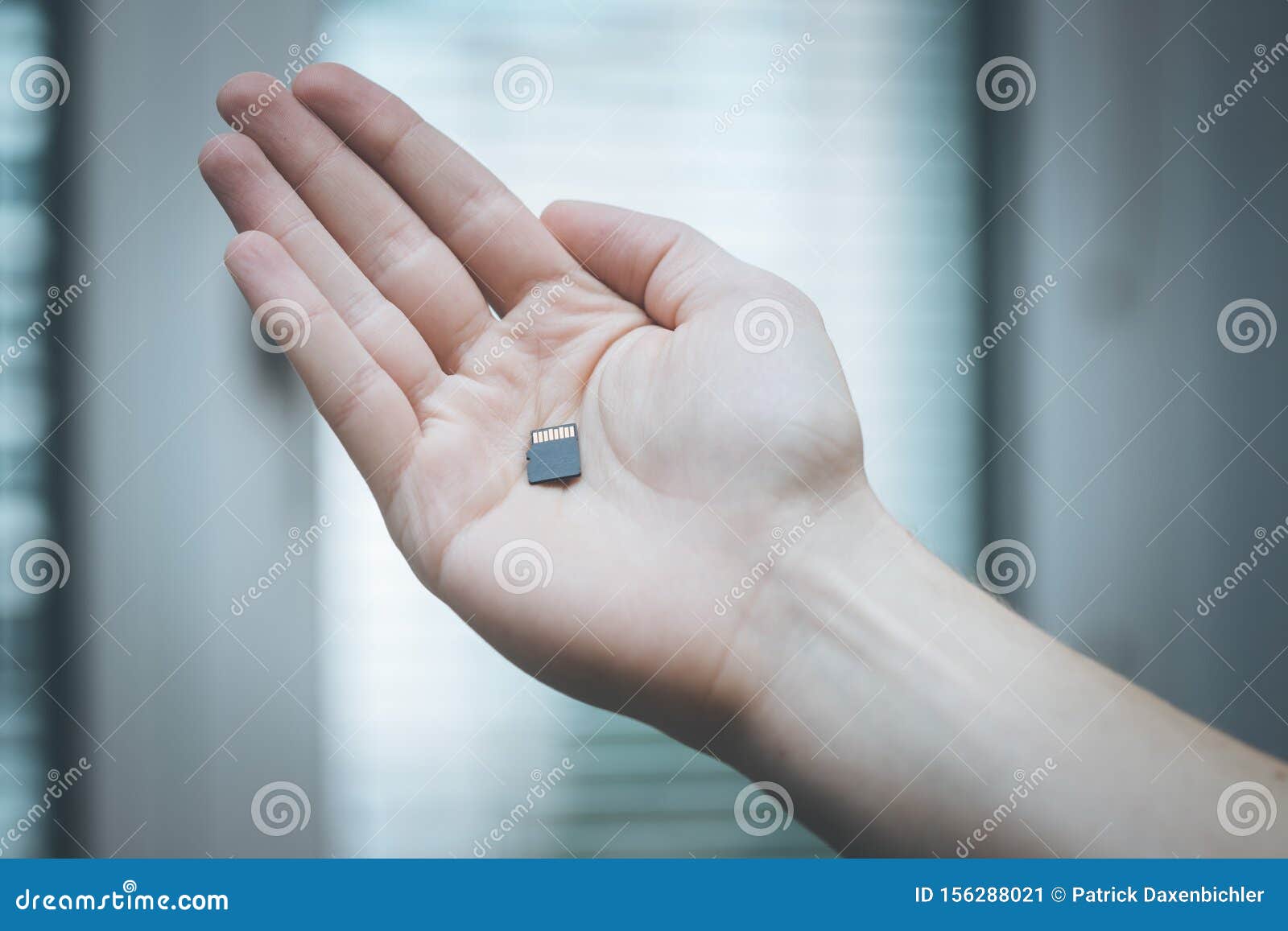 Young Man is Holding a Tiny Memory Card in His Hand, Text Space Stock ...