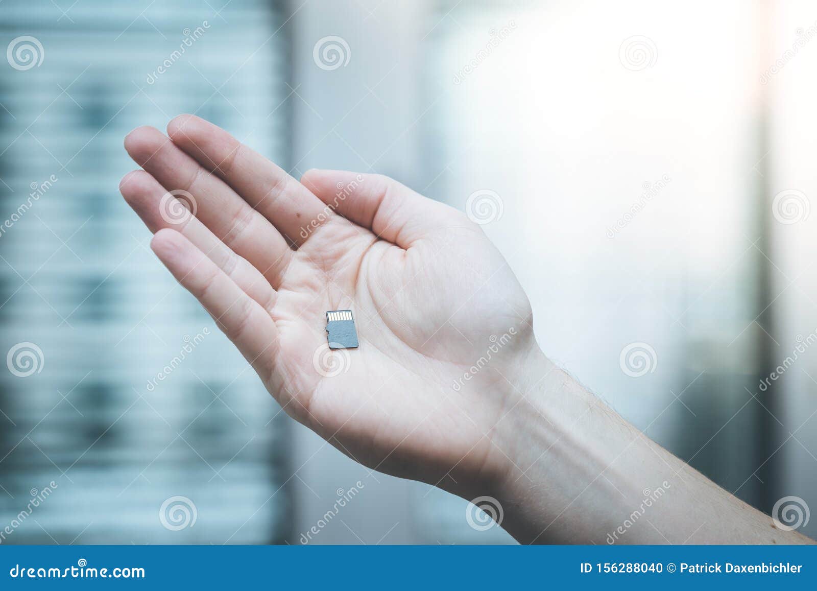 Young Man is Holding a Tiny Memory Card in His Hand, Text Space Stock ...