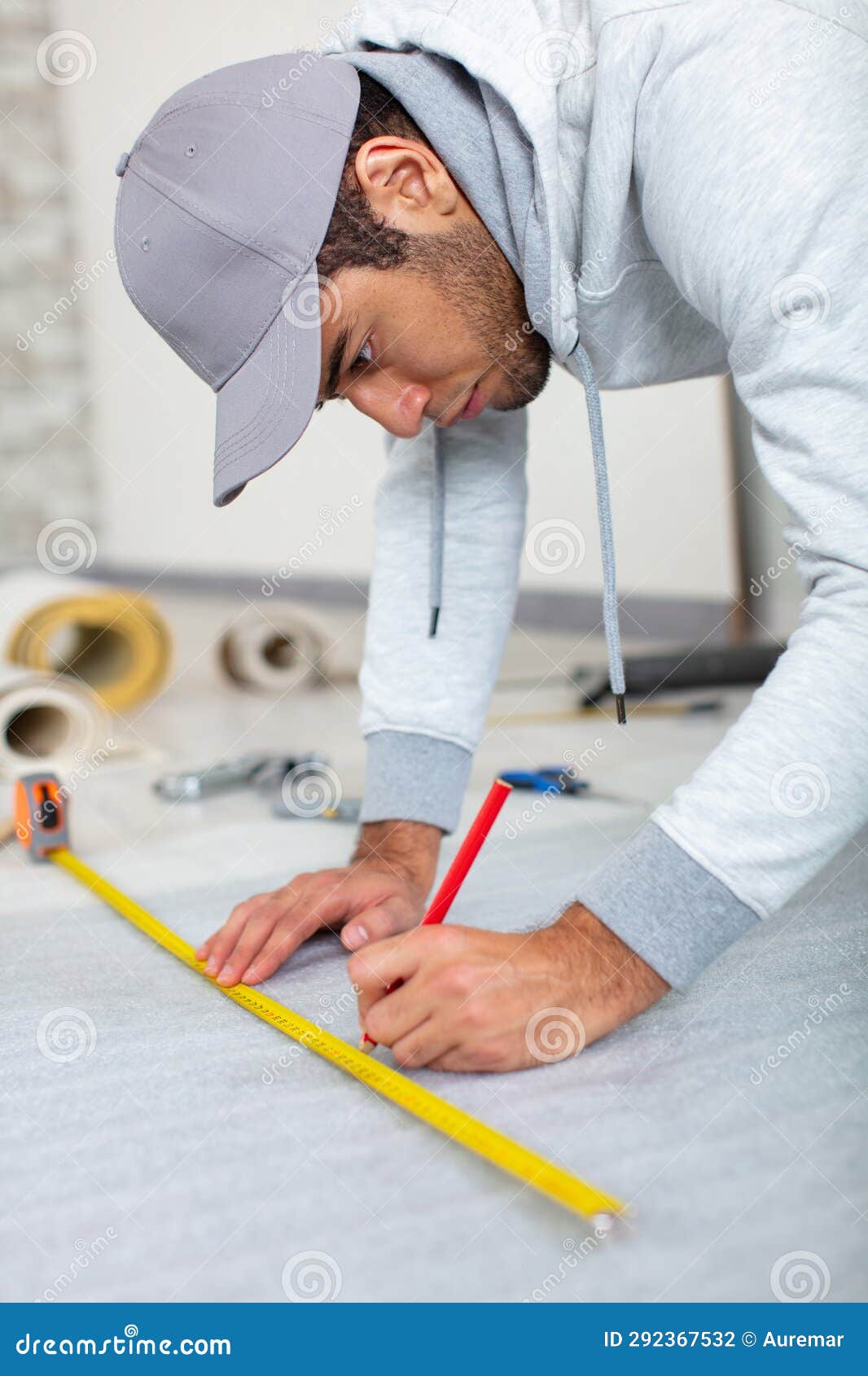 Young Man Holds Level for Measuring Floor Stock Photo - Image of brick ...