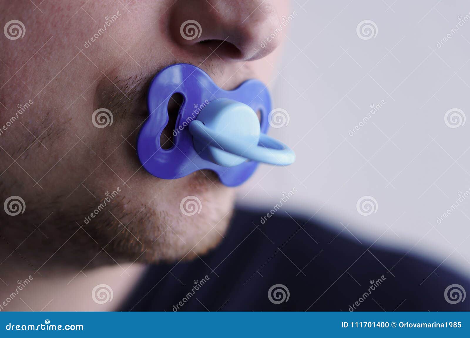 A Young Man Holds a Pacifier in His Mouth Stock Photo - Image of adult ...