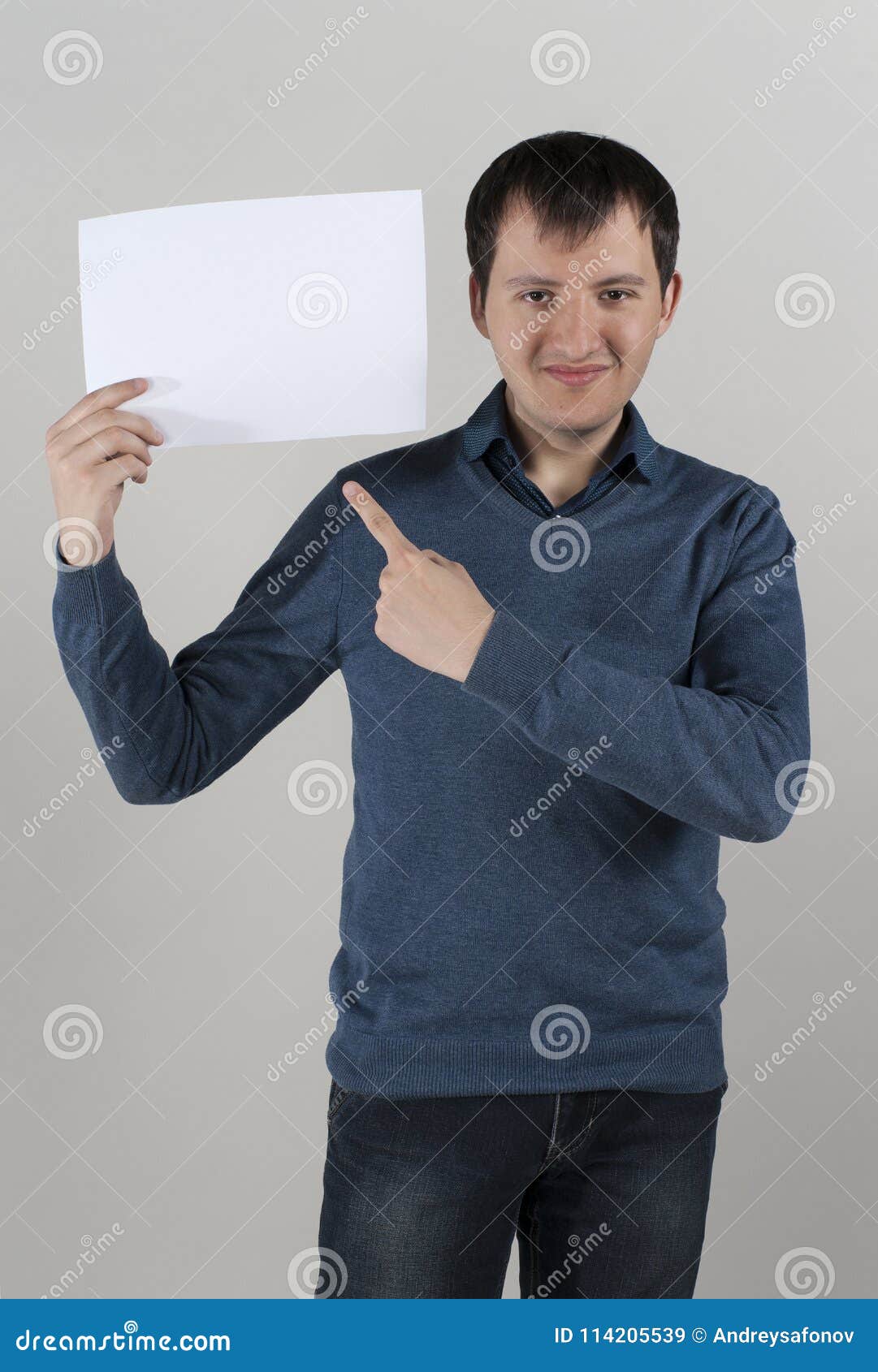 A Young Man Holds a White Sheet of Paper Stock Image - Image of showing ...