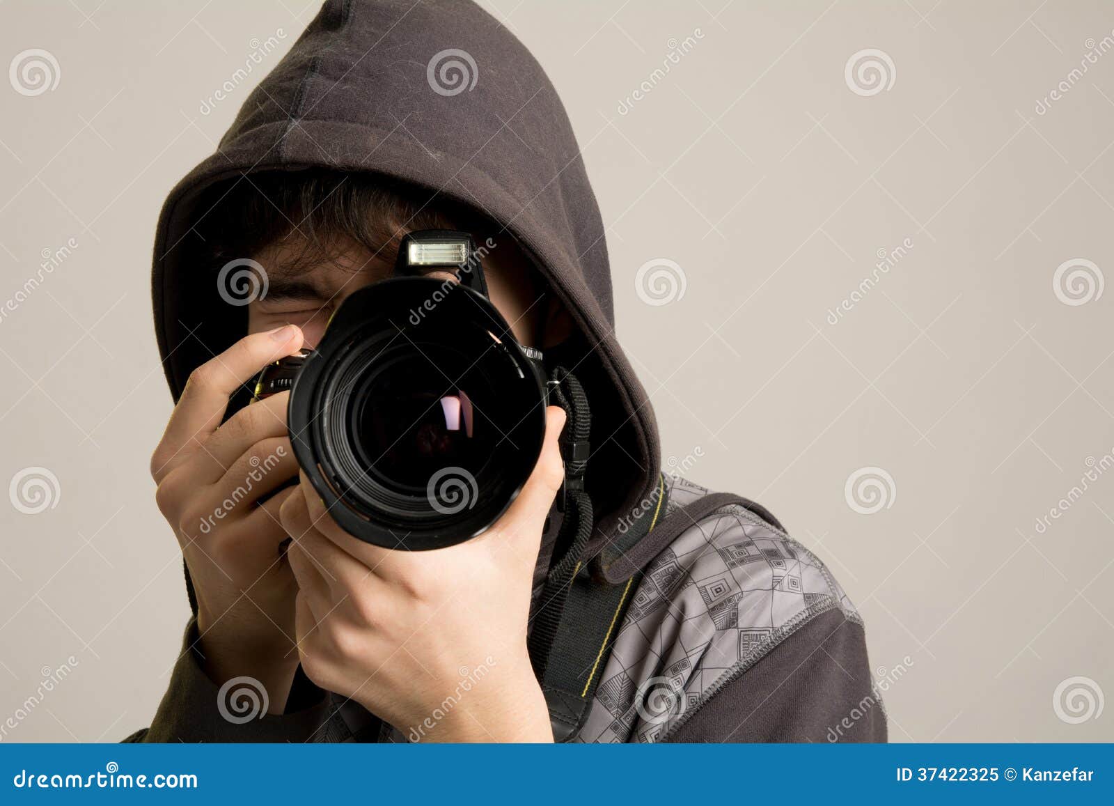 A Young Man in a Hood Using a Professional Camera Stock Image - Image ...