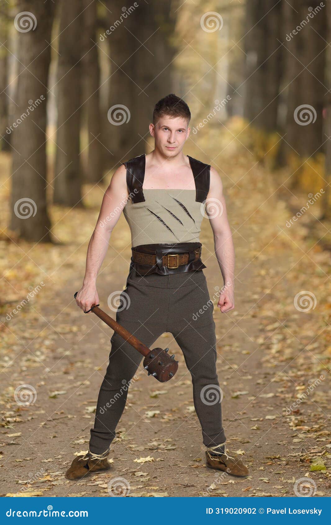 Young Man in Hunter Costume with Mace Poses in Stock Photo - Image of ...