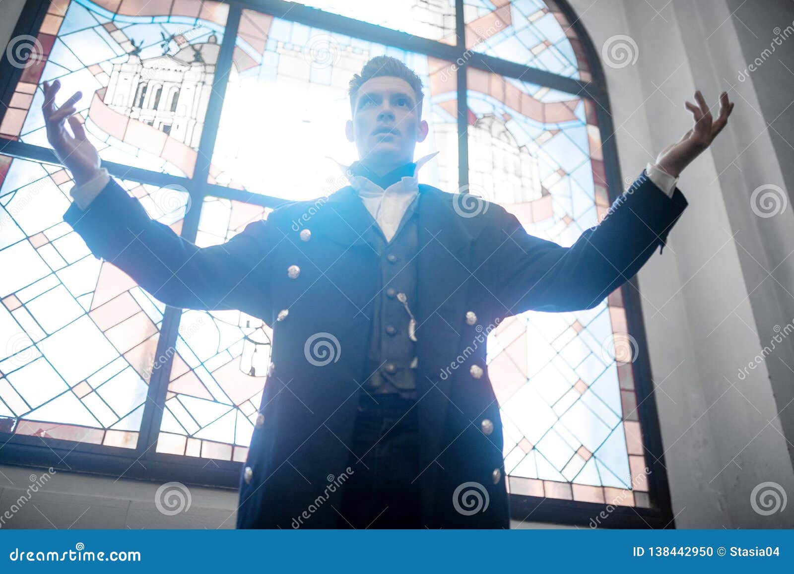 Young Man in Image of Black Magician Against Window Stock Photo - Image ...