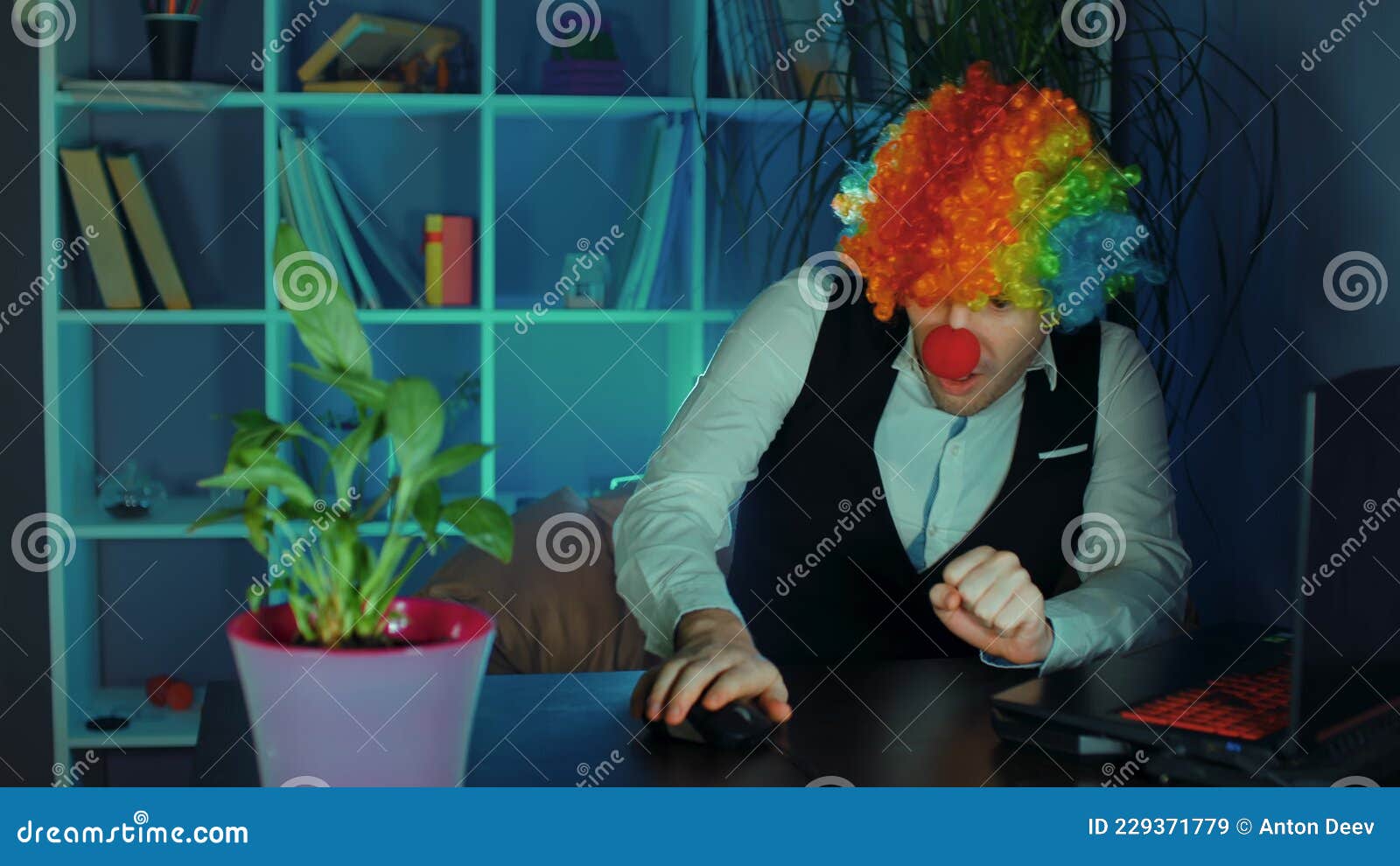 Young Man in Image of Clown Afraid of Computer Mouse in Office. Funny ...