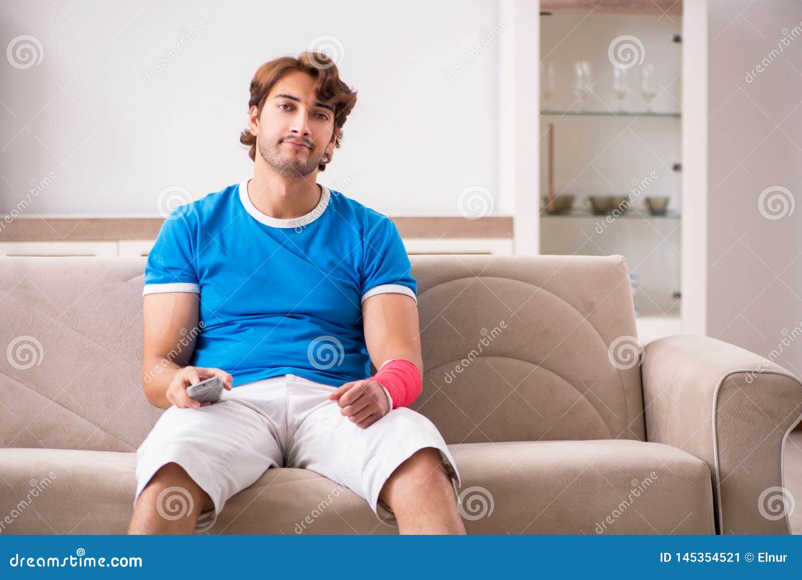 The Young Man with Injured Arm Sitting on the Sofa Stock Image - Image ...