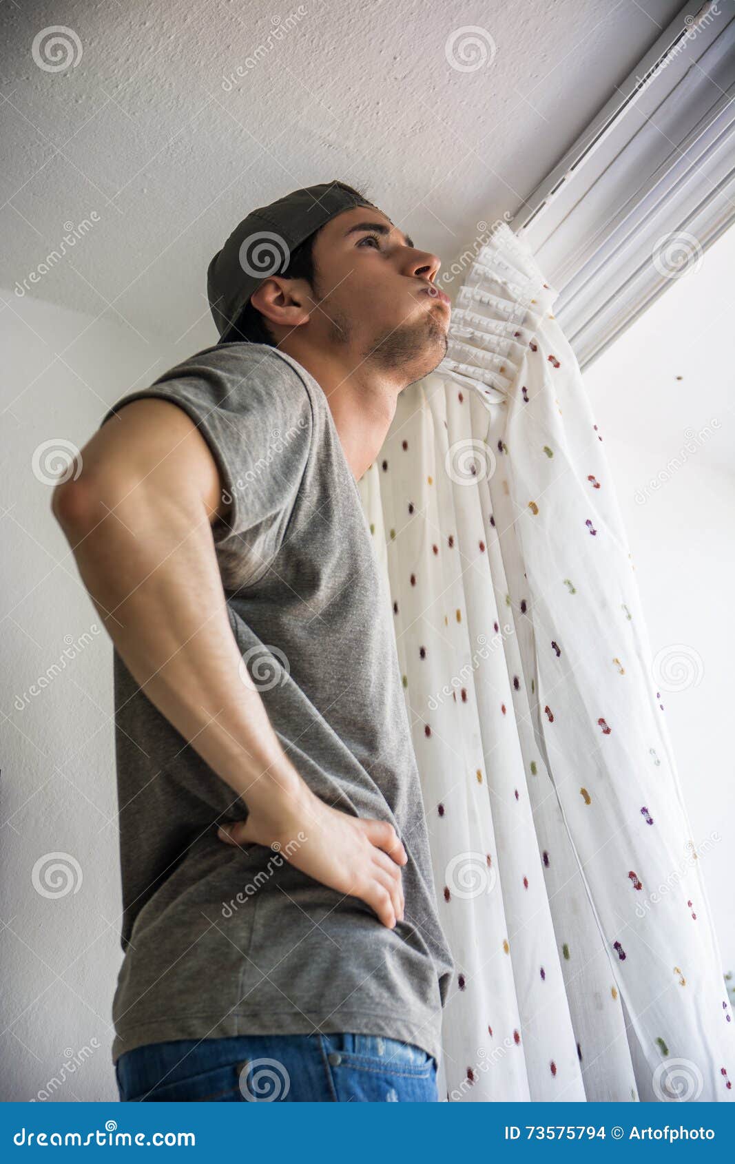 Young Man Installing Curtains Over Window Stock Photo - Image of ...