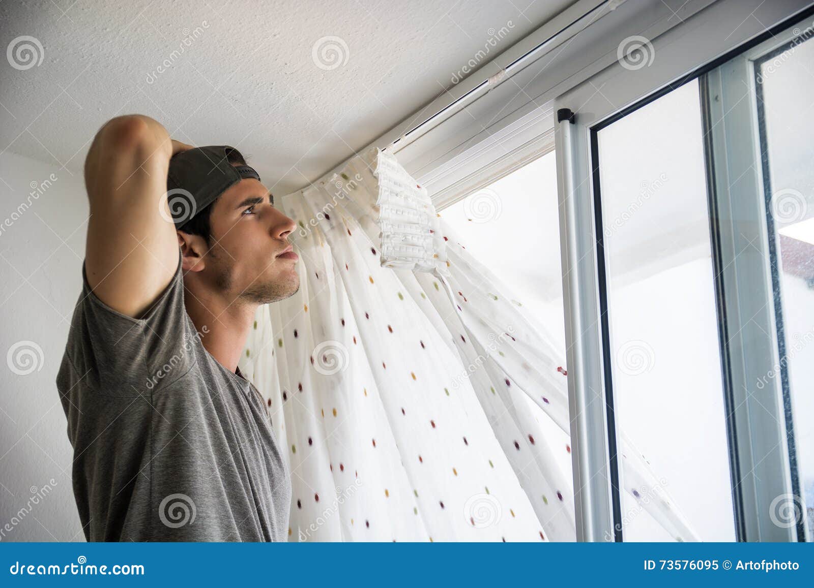 Young Man Installing Curtains Over Window Stock Image - Image of male ...