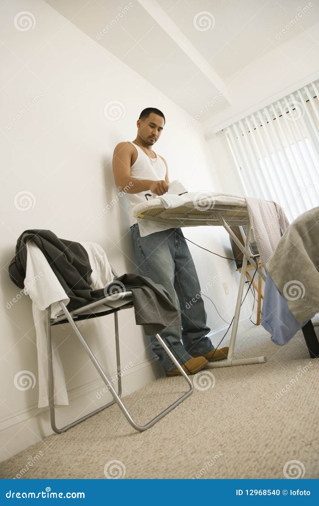 Young Man Ironing stock photo. Image of iron, chores - 12968540
