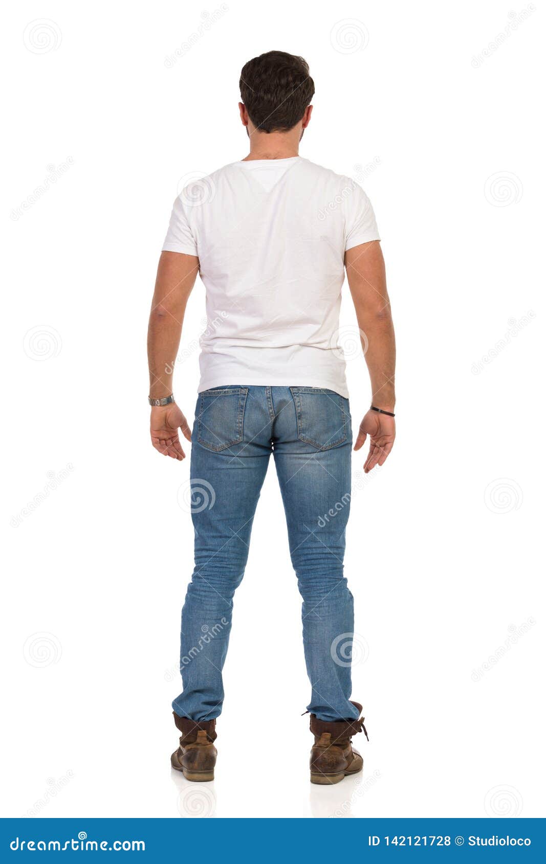 Young Man in Jeans and WhiteT-shirt is Standing Relaxed, Rear View ... Young Man in Jeans and WhiteT-shirt is Standing Relaxed, Rear View ...
