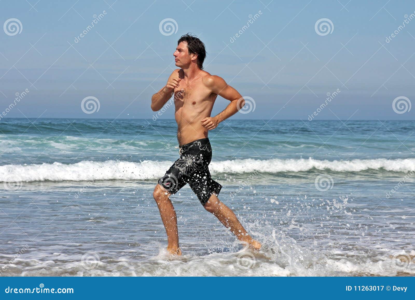 Young Man Jogging Along the Beach at the Atlantic Stock Image - Image ...