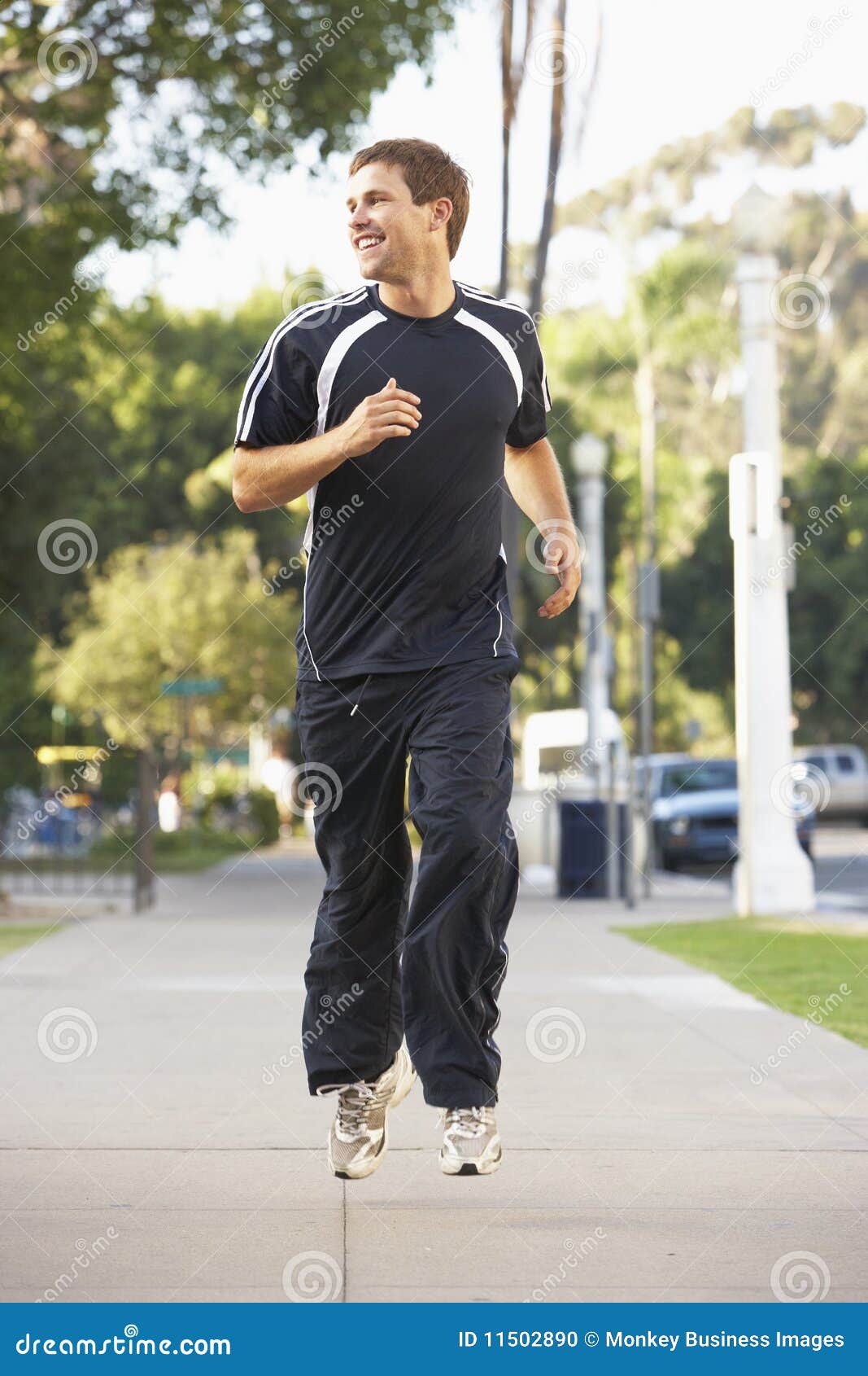 Young Man Jogging on Street Stock Photo - Image of exercising, sidewalk ...