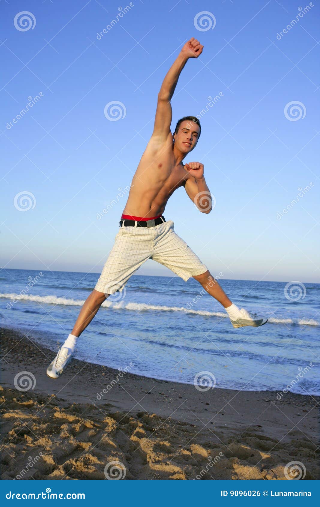 Young Man Jumping on the Blue Beach Stock Photo - Image of lifestyle ...