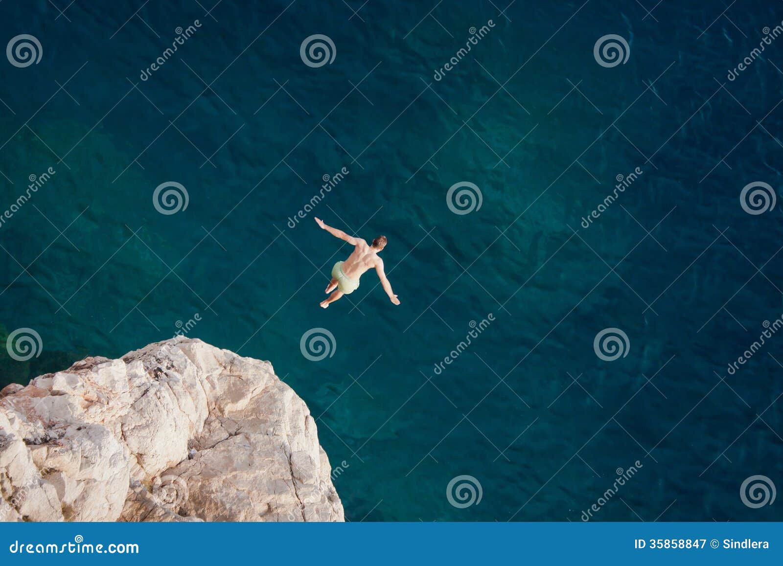 Jumping From The Cliff Near Sarakiniko Beach In Milos In The Cyclades ...