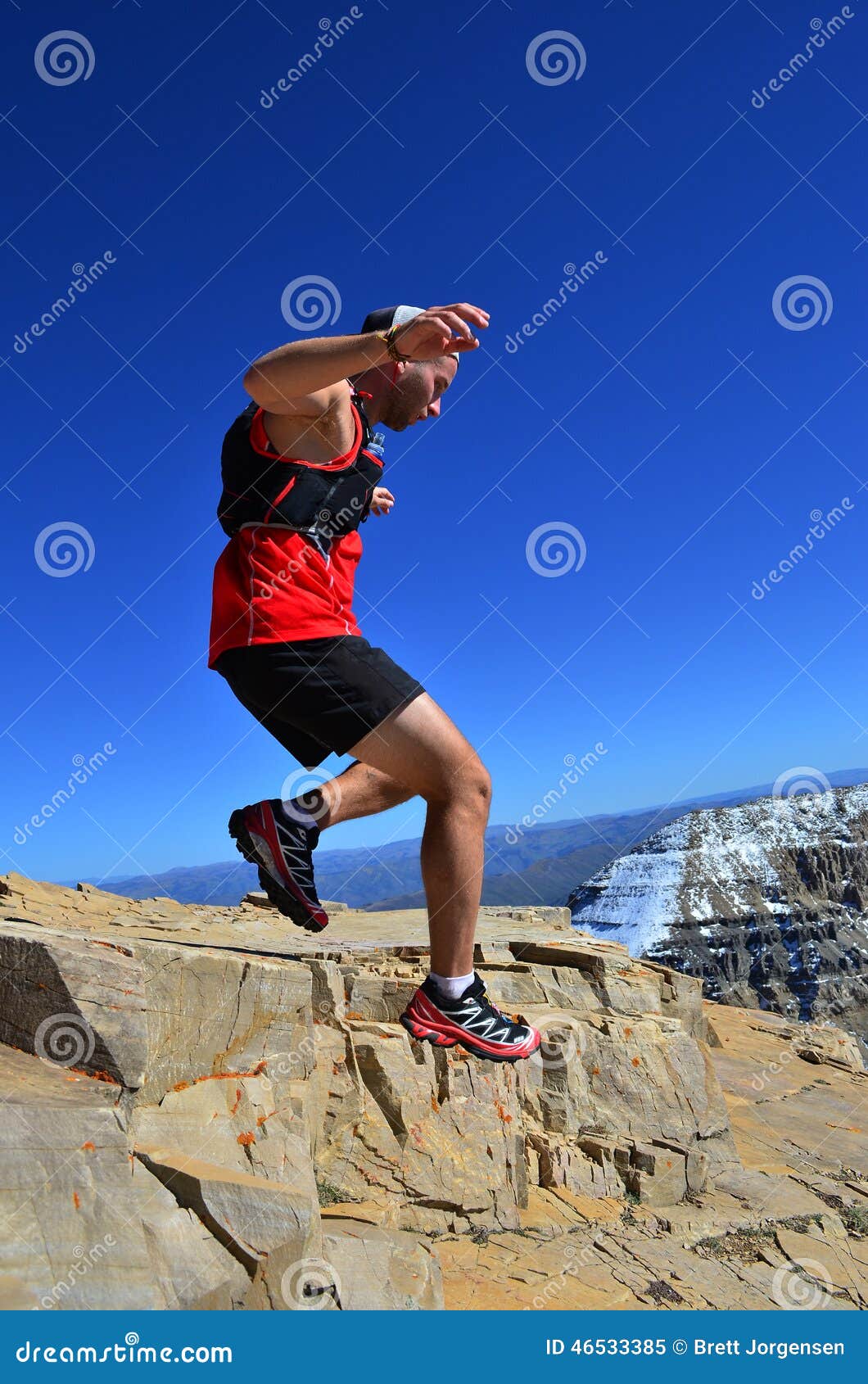 Young Man Jumping Down Rocks on a Mountain Stock Image - Image of ...