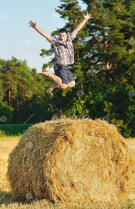 Young Man Jumping on a Haystack Stock Photo - Image of agriculture ...