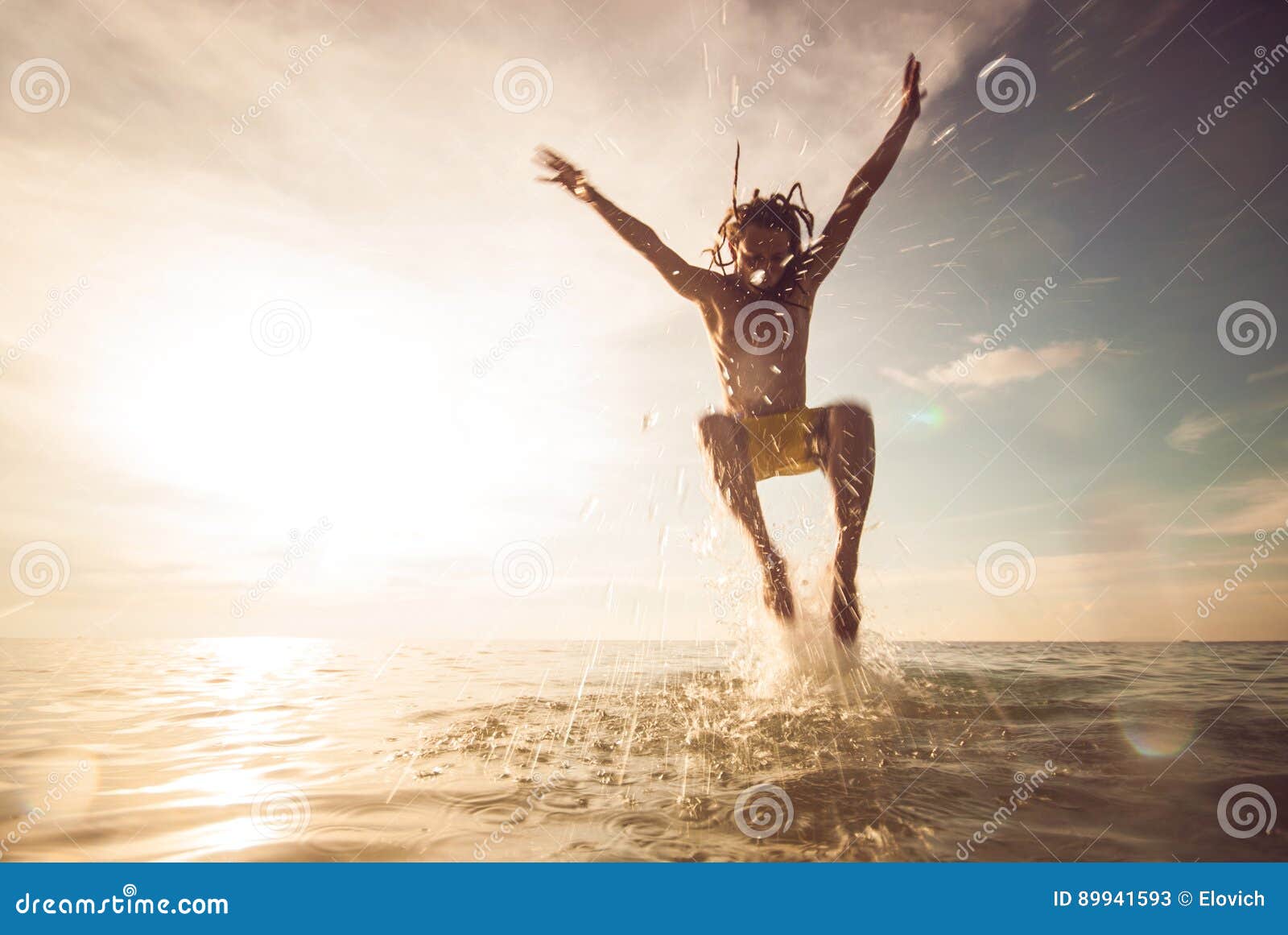 Young Man Jumping in the Sea Stock Image - Image of happy, sunset: 89941593