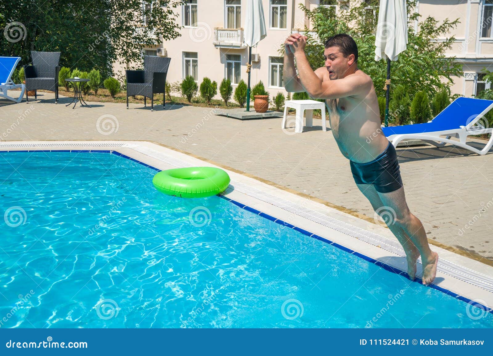 Young Man Jumping in Swimming Pool at Resort Stock Image - Image of ...