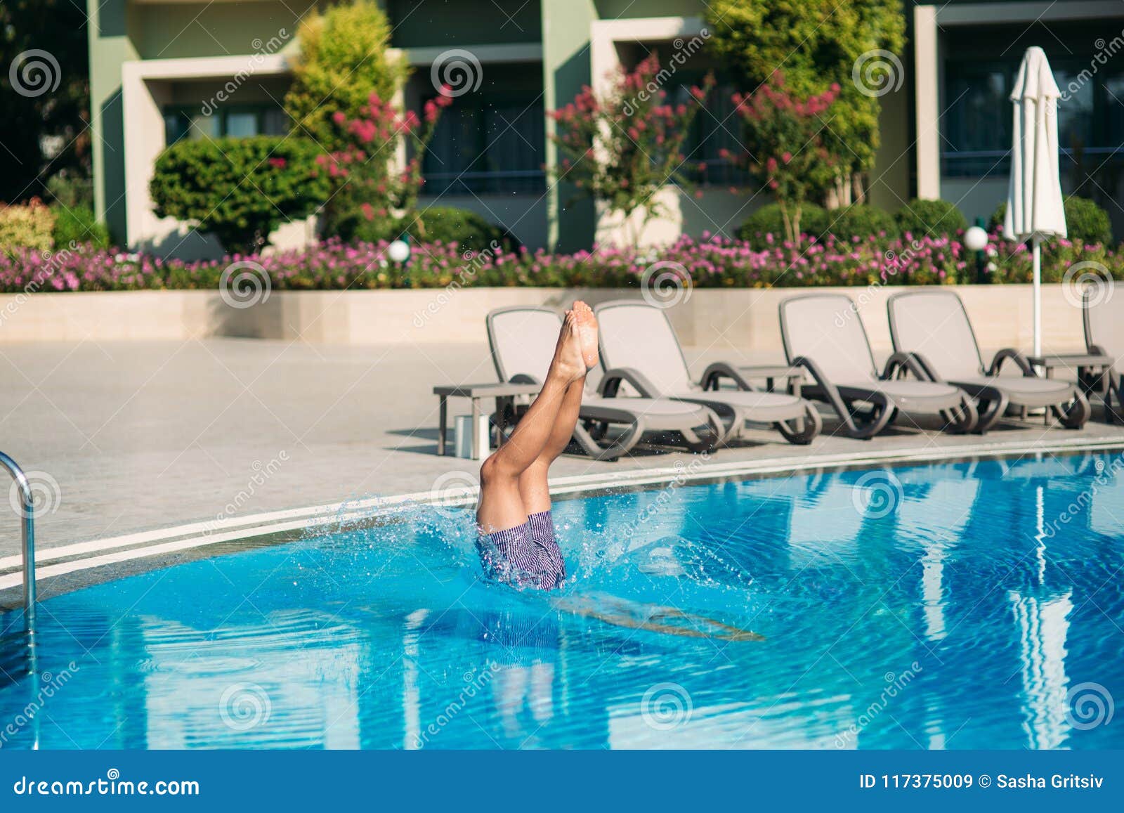 Young Man Jumping in Swimming Pool at Resort Stock Image - Image of ...