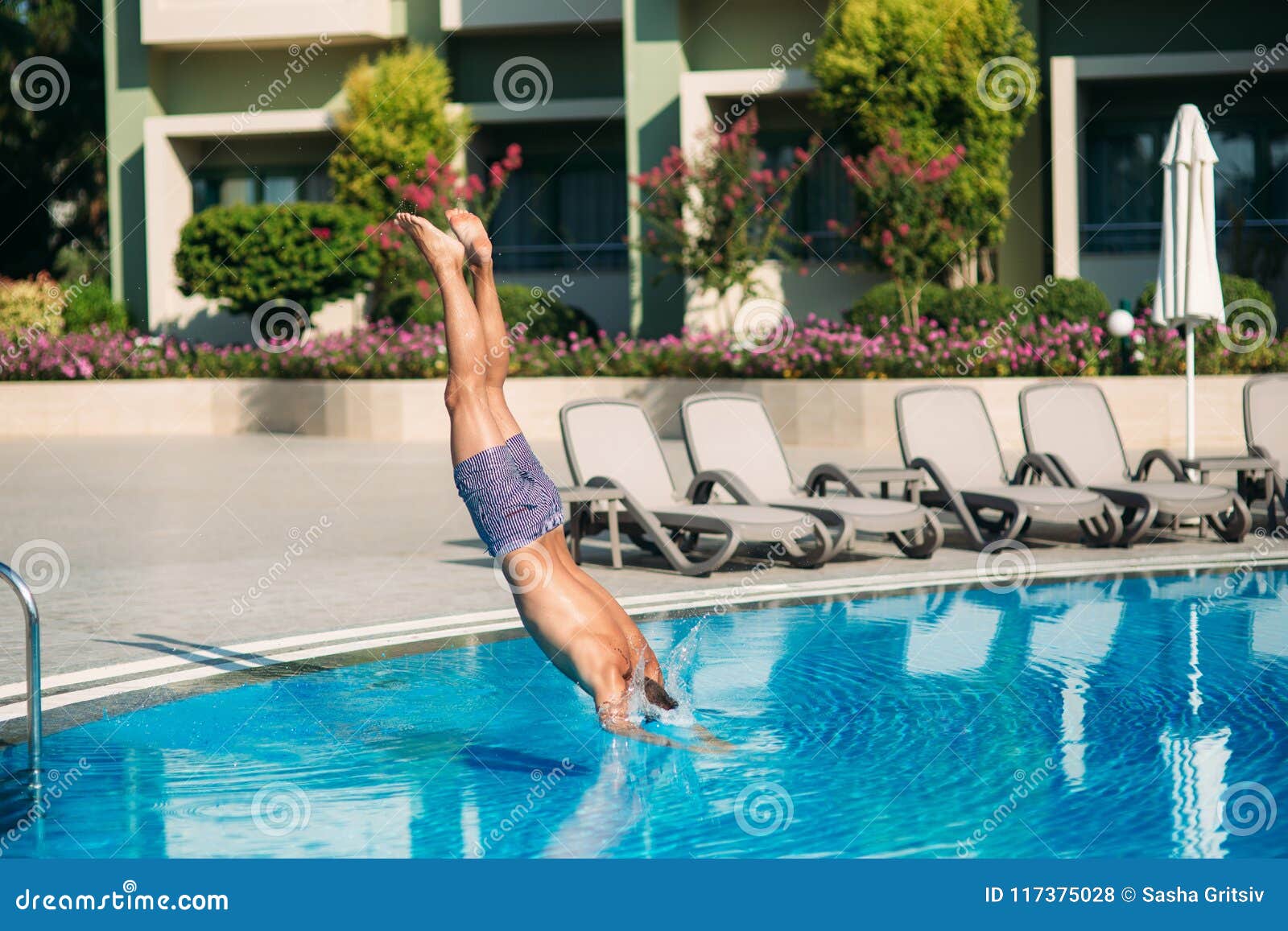 Young Man Jumping in Swimming Pool at Resort Stock Photo - Image of ...