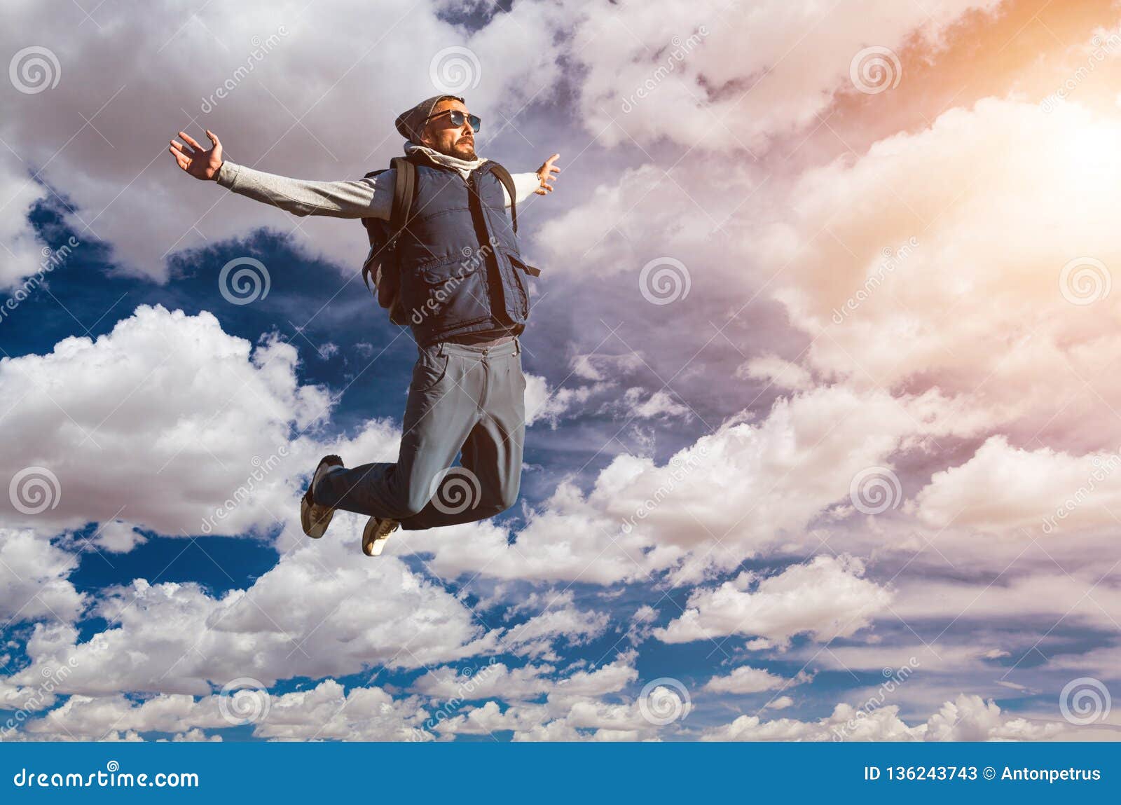 Young Man Jumping on Top of a Mountain Against the Sky Stock Image ...
