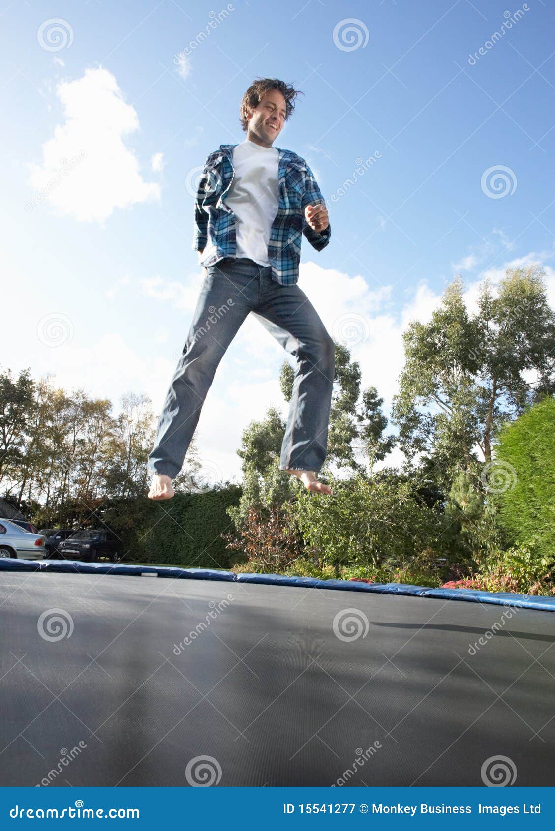 Young Man Jumping on Trampoline Caught in Mid Air Stock Image - Image ...