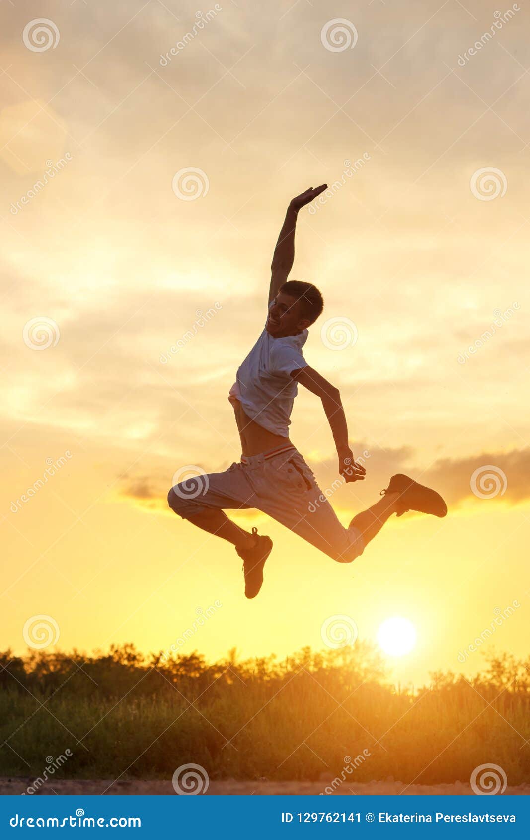 Young Man Jumping Up Against the Sunset Sky Stock Image - Image of ...
