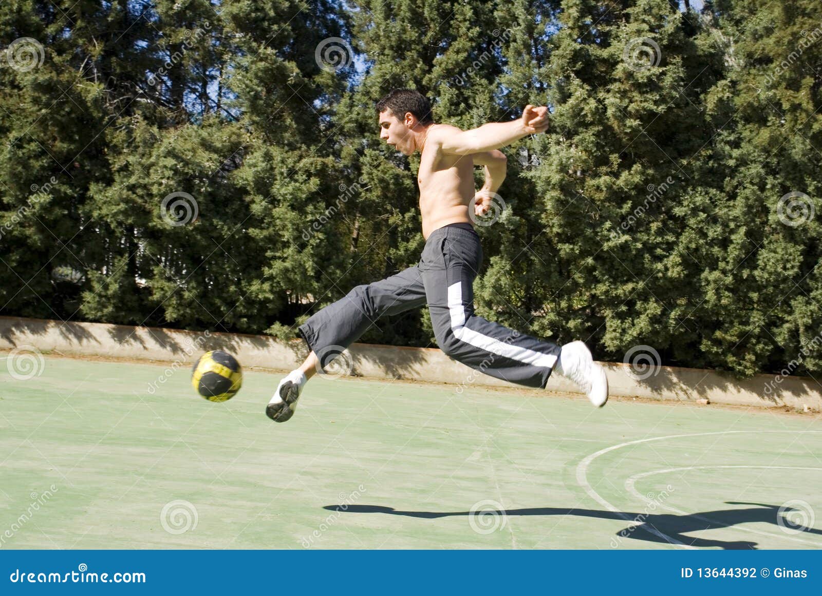 Young man kicking ball stock photo. Image of relaxation - 13644392