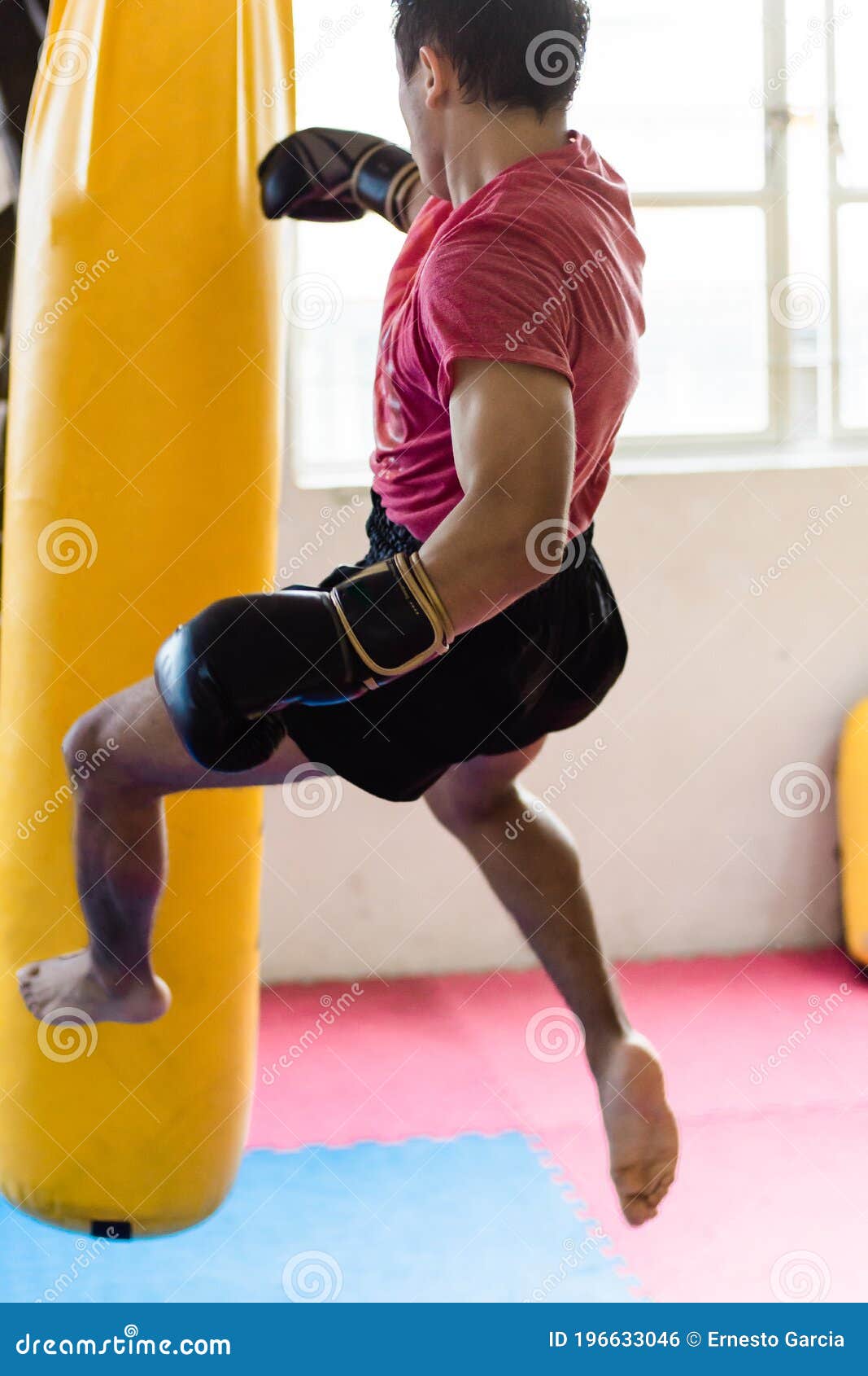 Young Man Kicking a Boxing Bag in the Gym Stock Photo - Image of punch ...