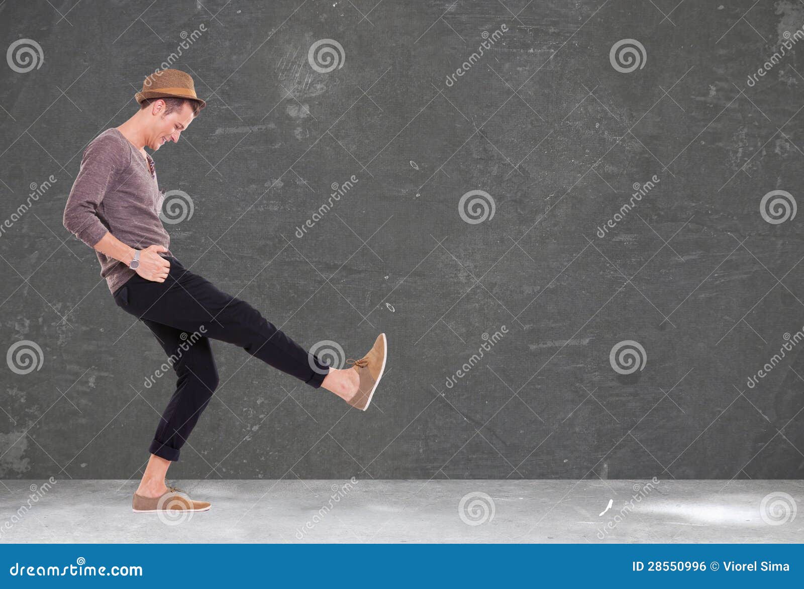 Young Man Kicking and Smiling Stock Photo - Image of clothing ...