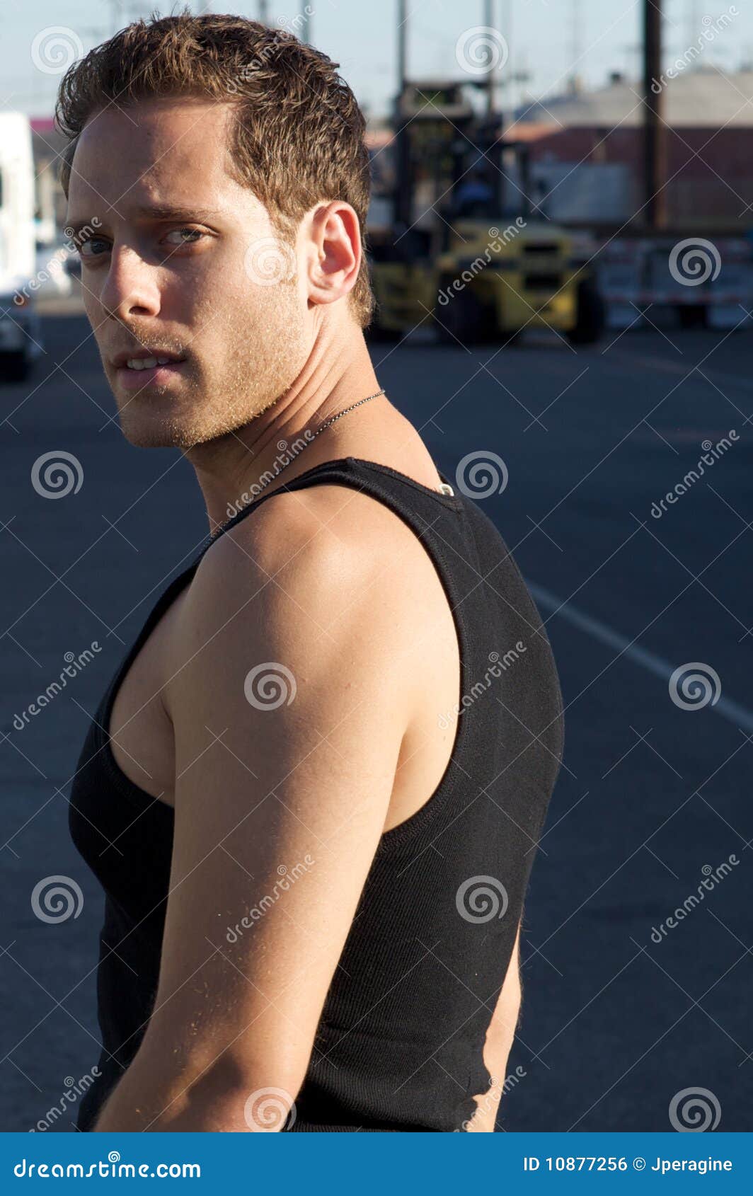 Young Man Kneeling Next To Train Tracks Stock Photo - Image of coat ...