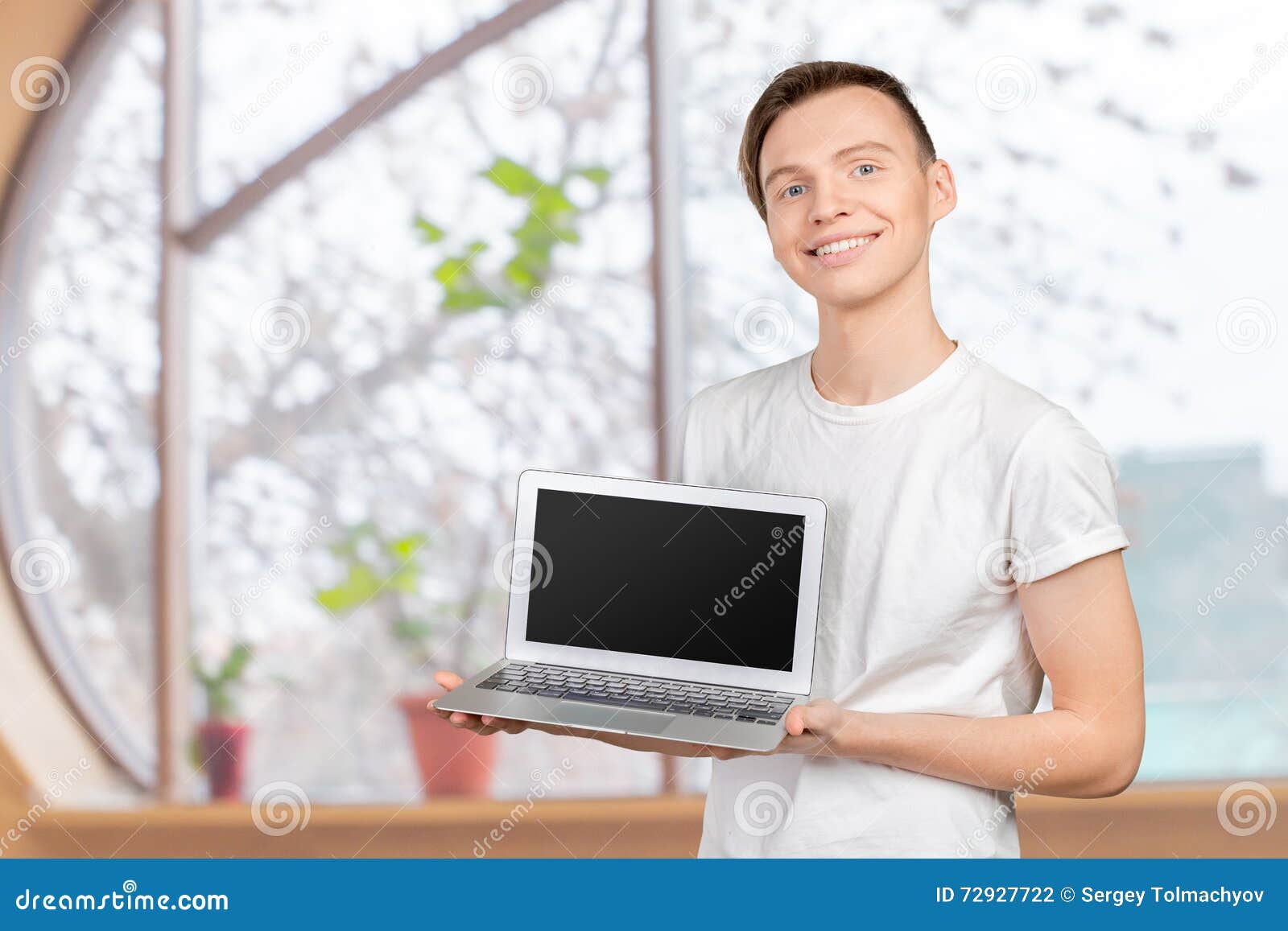 Young man with laptop stock photo. Image of success, stand - 72927722