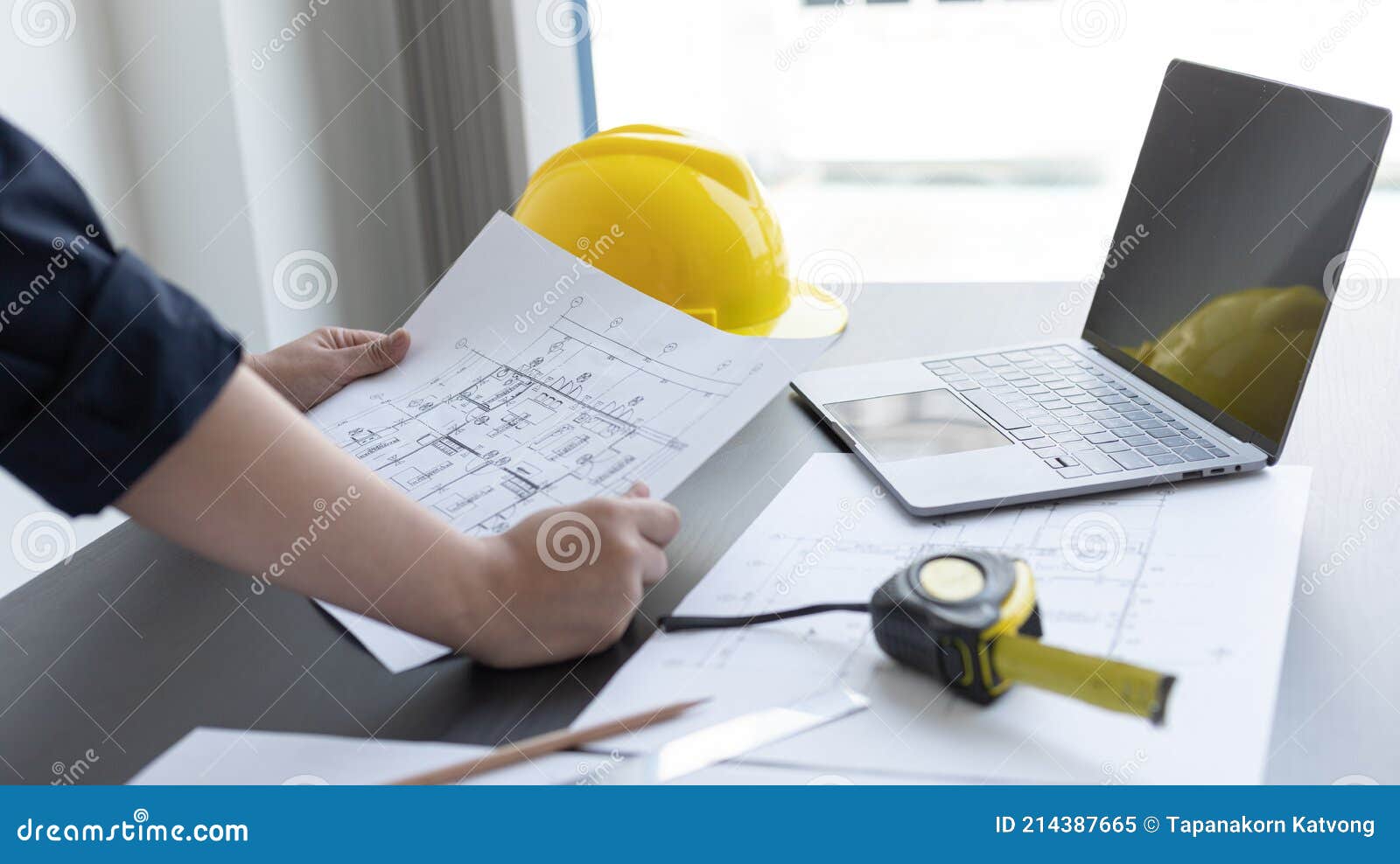 Young Man with a Laptop Plotting a System of Building Structures in ...