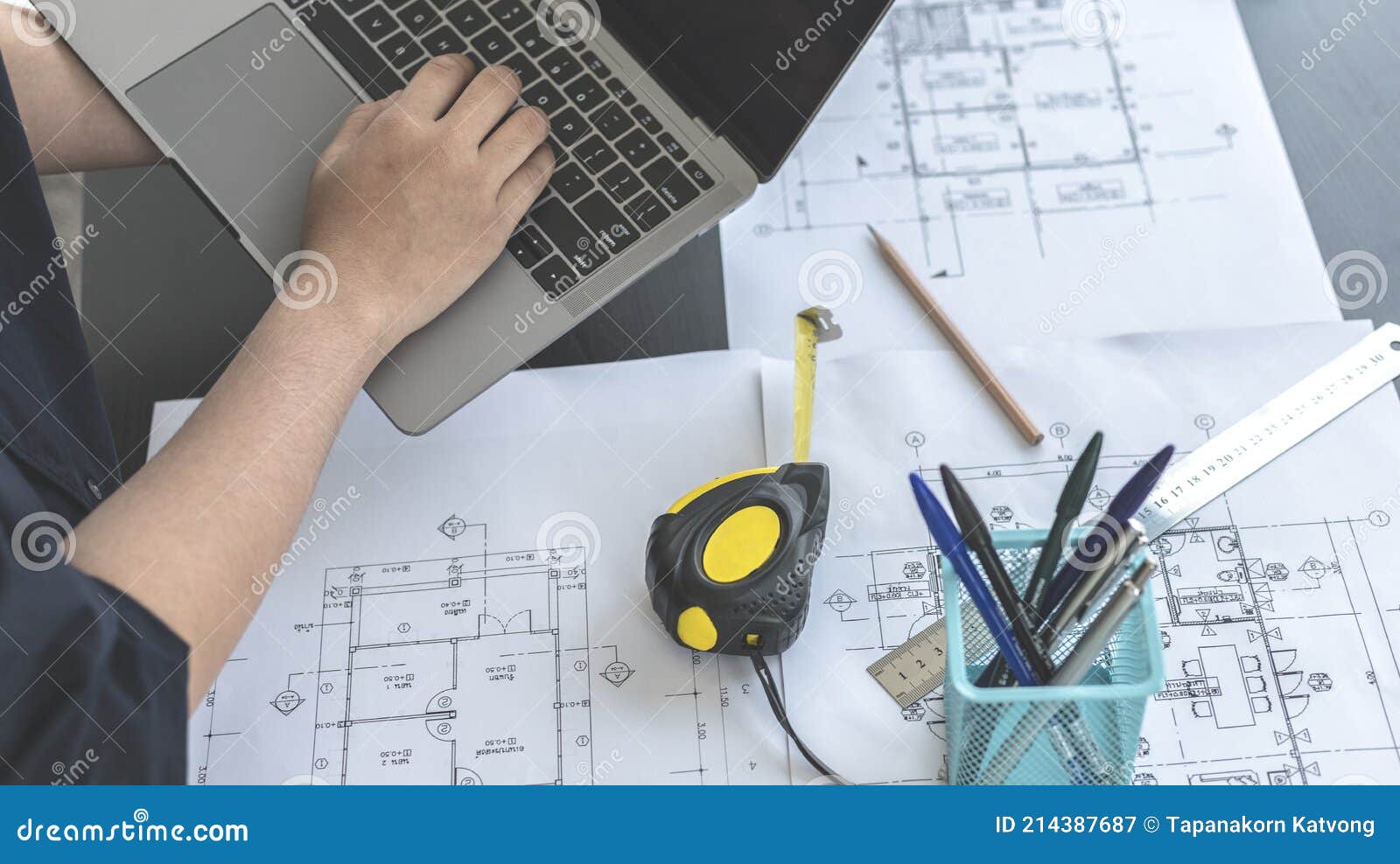 Young Man with a Laptop Plotting a System of Building Structures in ...