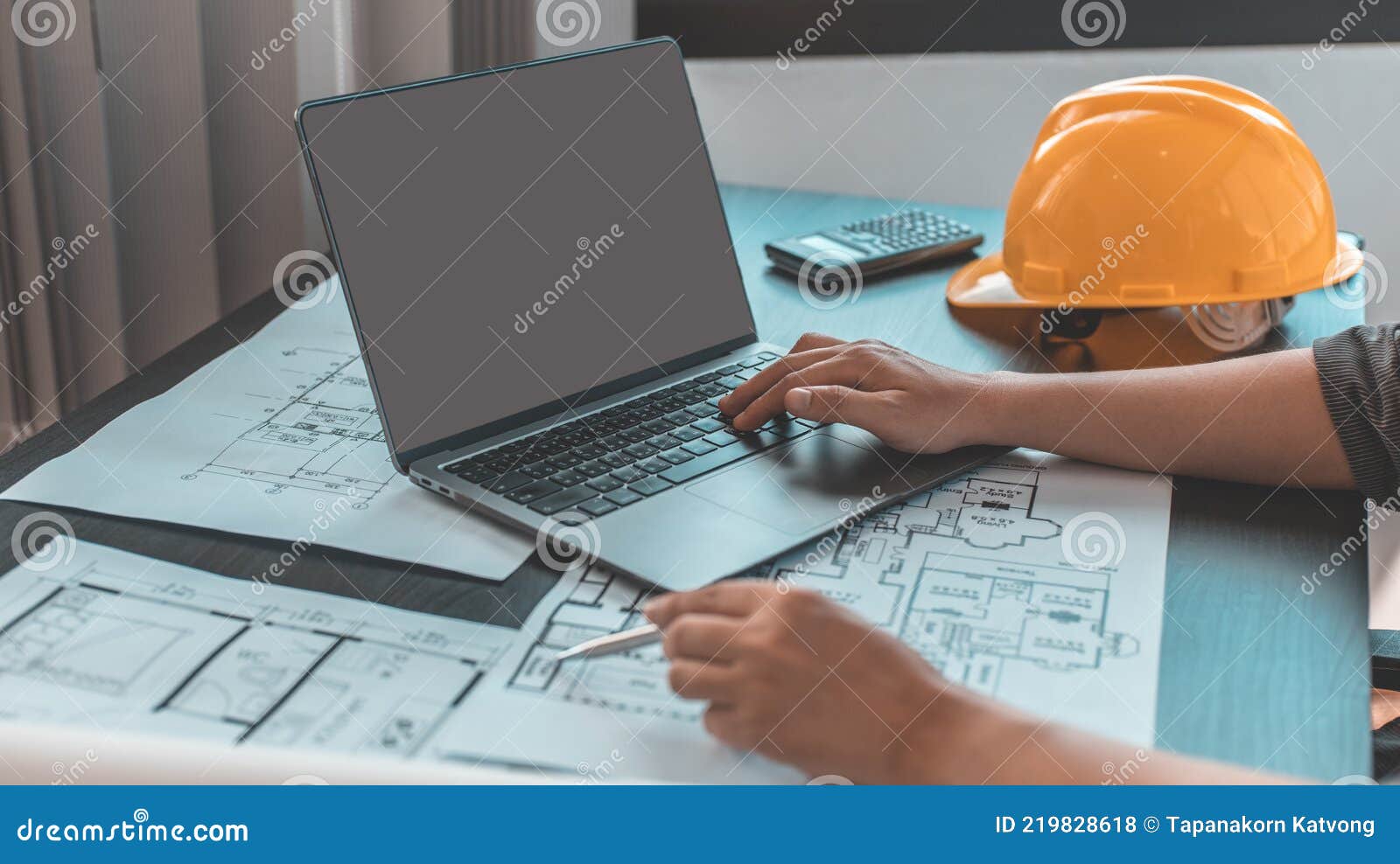 Young Man with a Laptop Plotting a System of Building Structures in ...