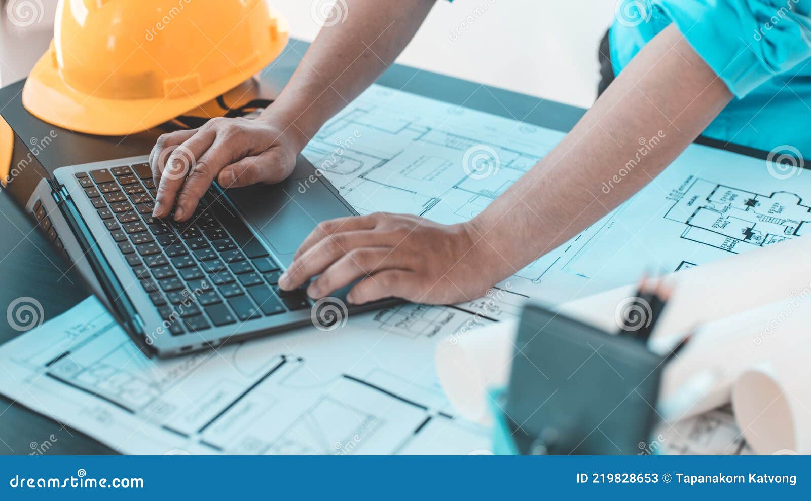 Young Man with a Laptop Plotting a System of Building Structures in ...